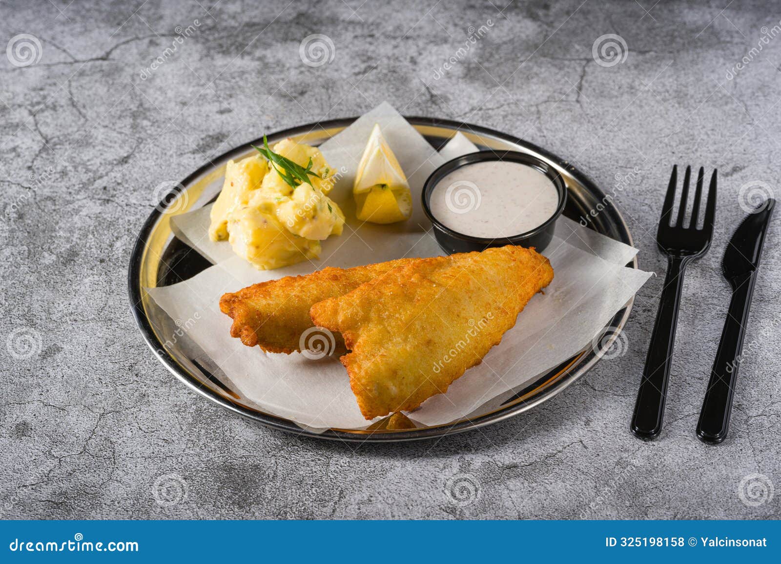 Deep Fried Coated Fish Fillet with Potato Salad on Stone Table Stock ...