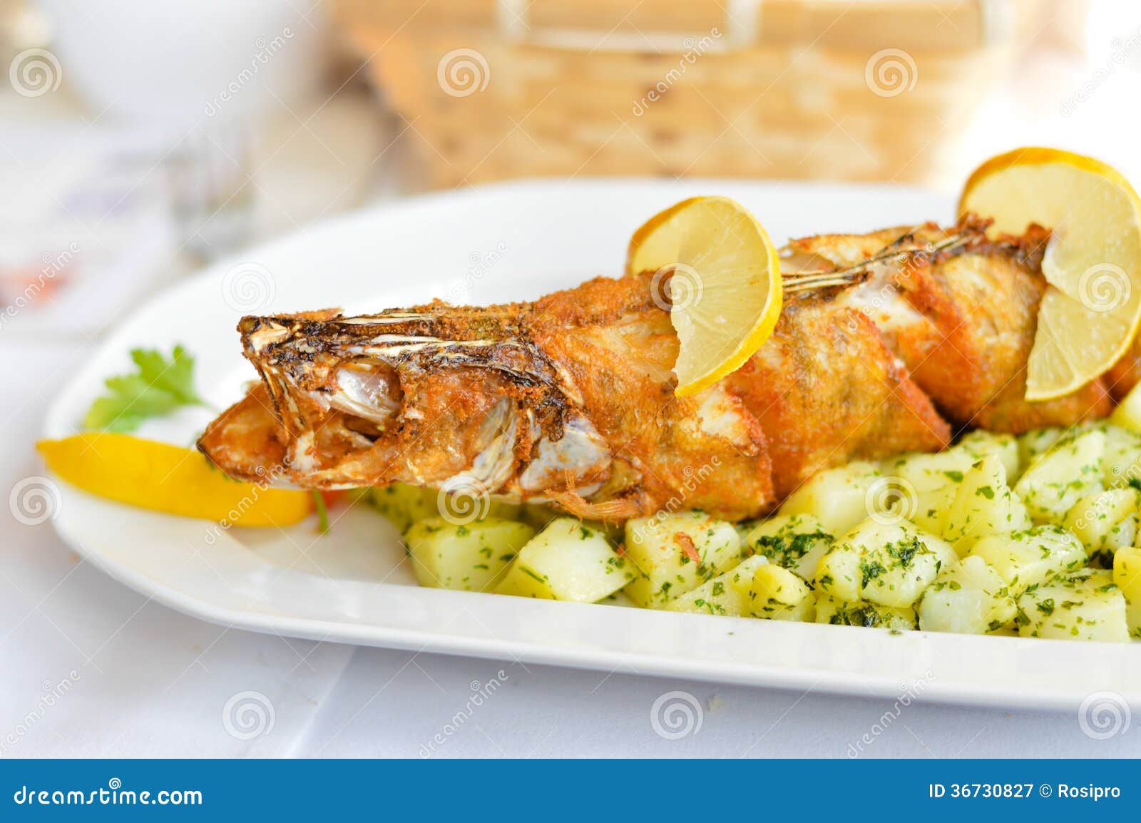 Deep Fried Pike Fish on Boiled Potato Pillow with Butter and Herbs ...