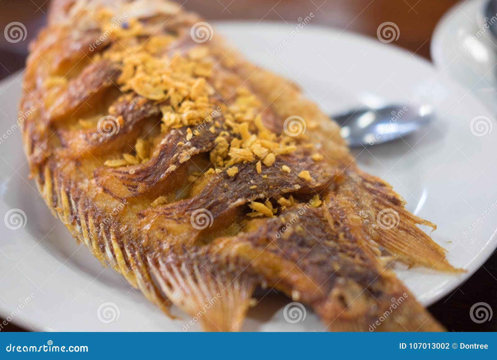 Deep Fried Ruby Fish with Garlic Stock Photo - Image of stir, herbs ...