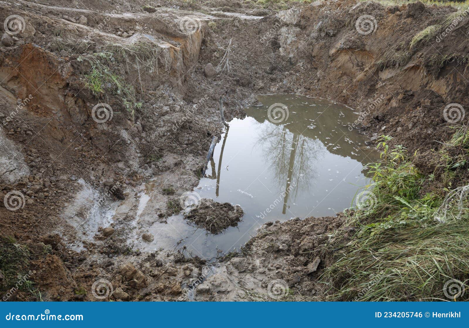 Deep Hole with Water after Digging for Installing New Water Pipes Stock ...