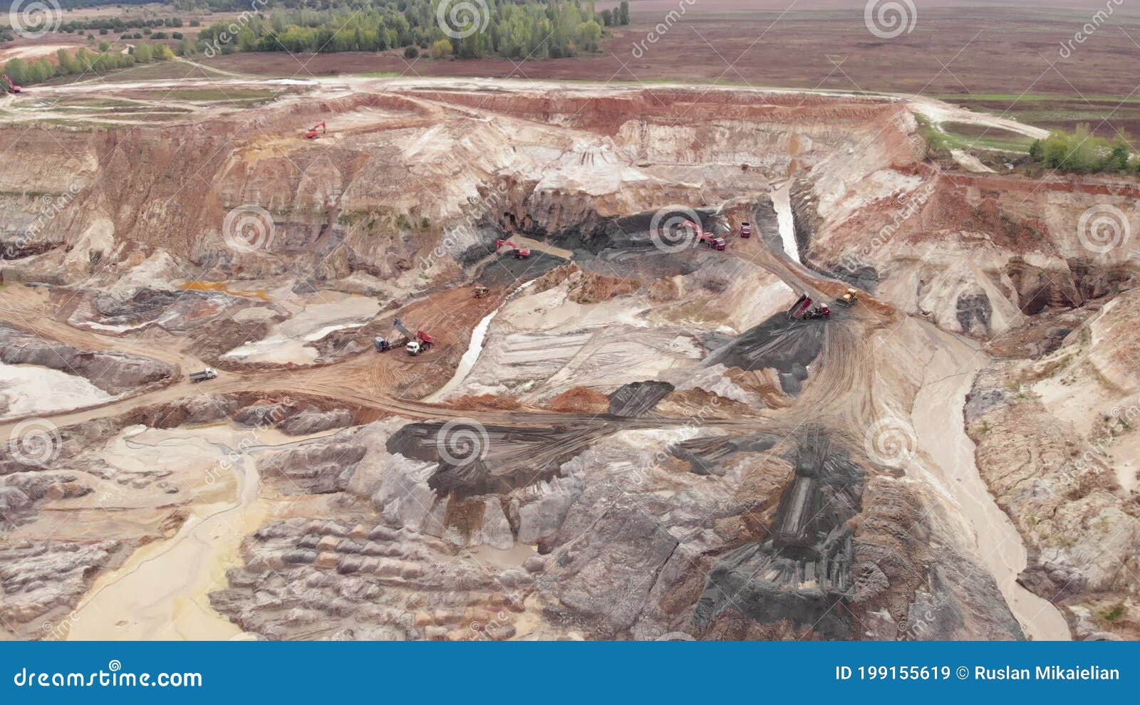 Deep Huge Mining Quarry with Huge Mounds of Minerals. Excavators are ...