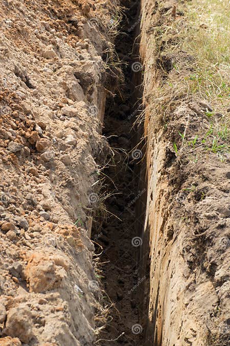 Deep narrow ditch in land stock photo. Image of earth - 66230752