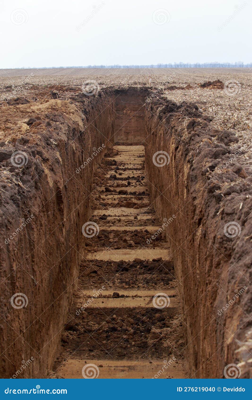 Deep trench in the soil stock photo. Image of excavating - 276219040