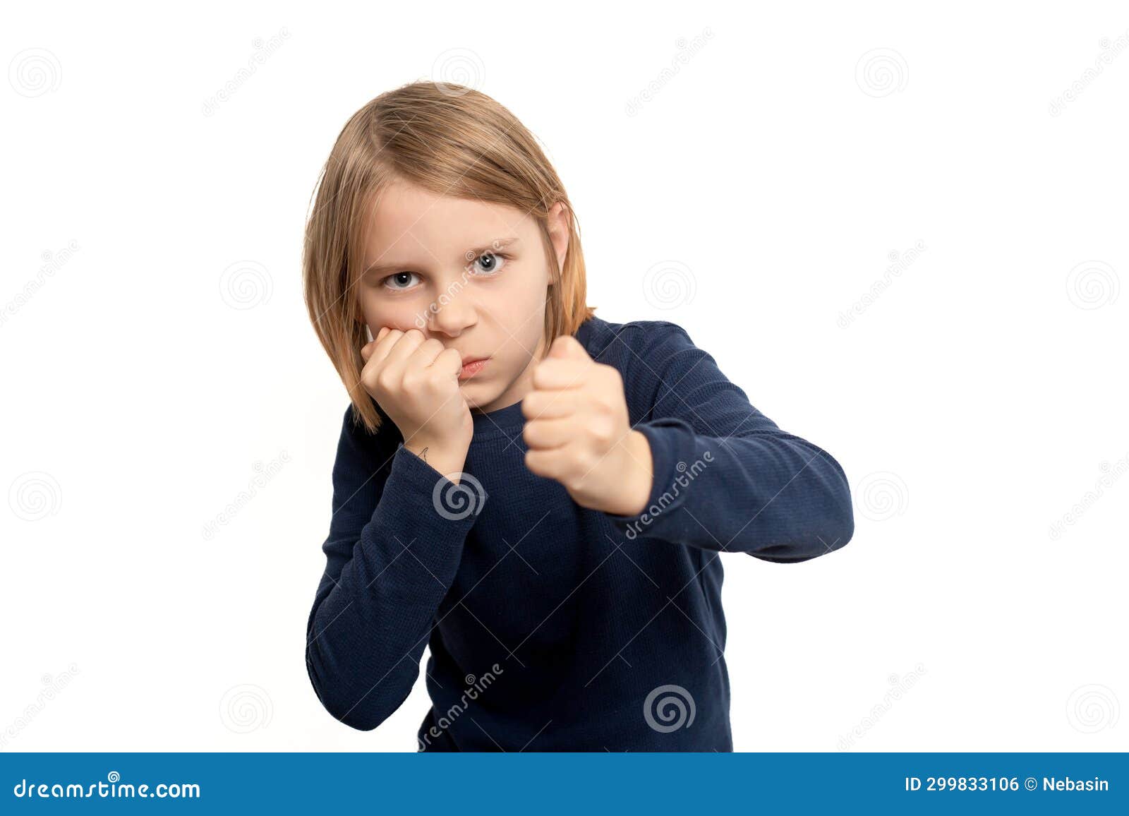 In a Defensive Pose, a Boy of Ten with Flowing Locks Practices Martial ...