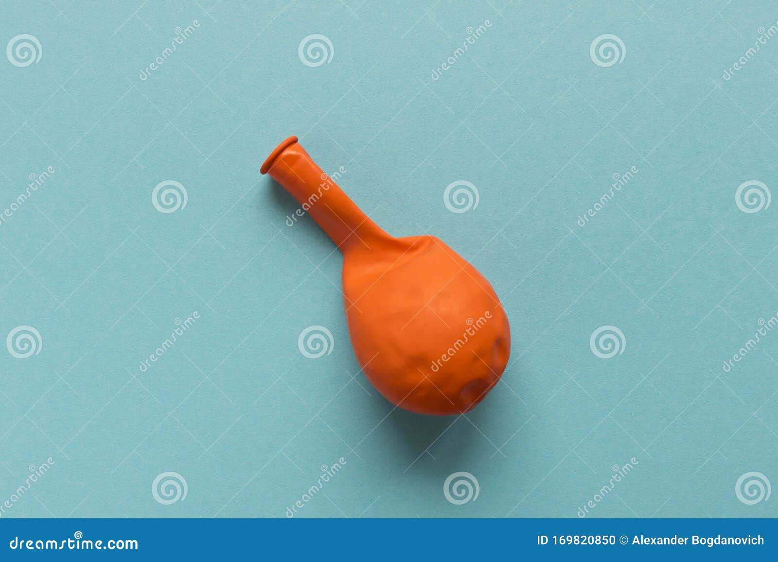 A Deflated Orange Balloon on a Blue Background Stock Photo - Image of ...