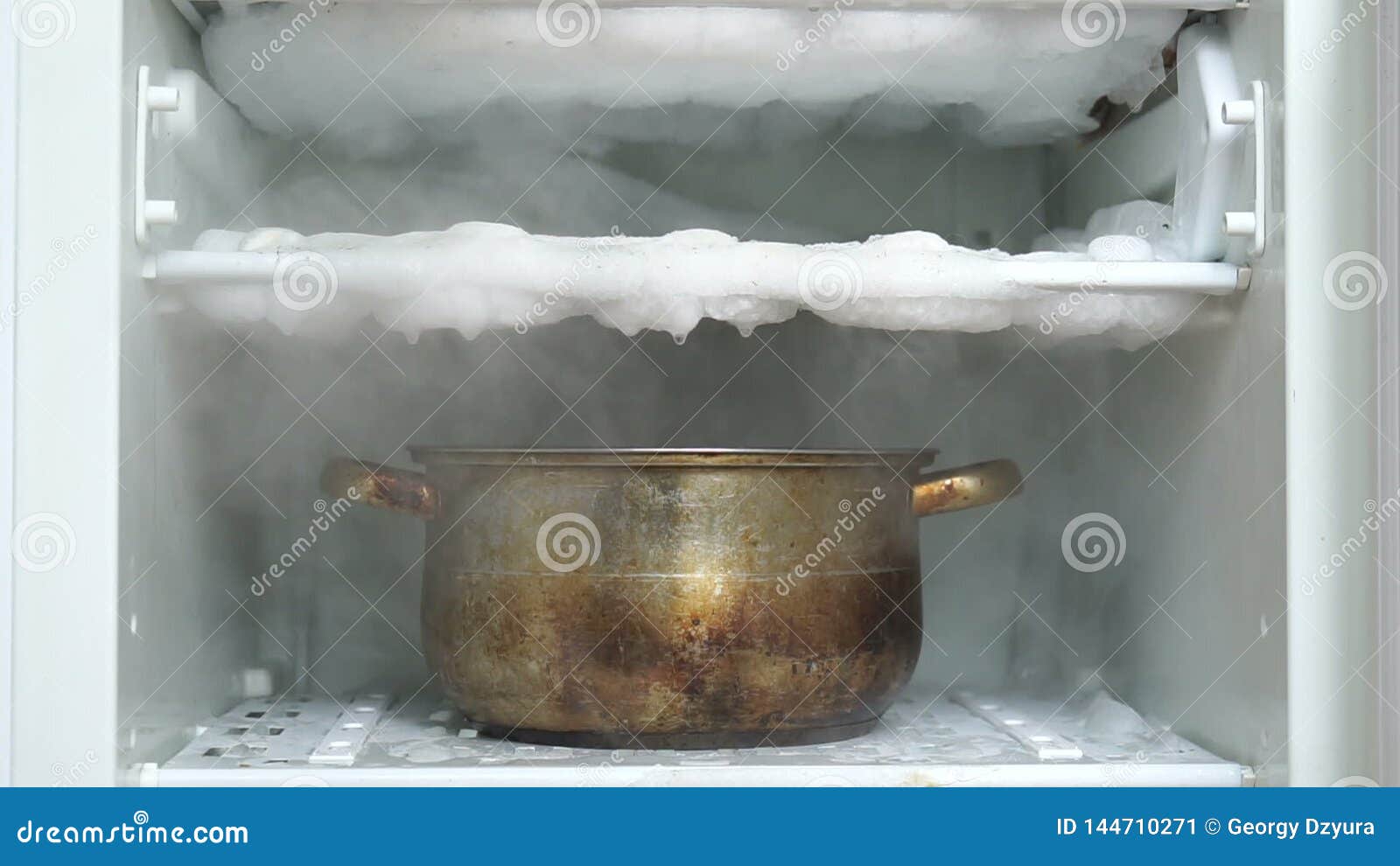 Defrosting a Refrigerator Using Big Kitchen Saucepan Full of Hot Water ...
