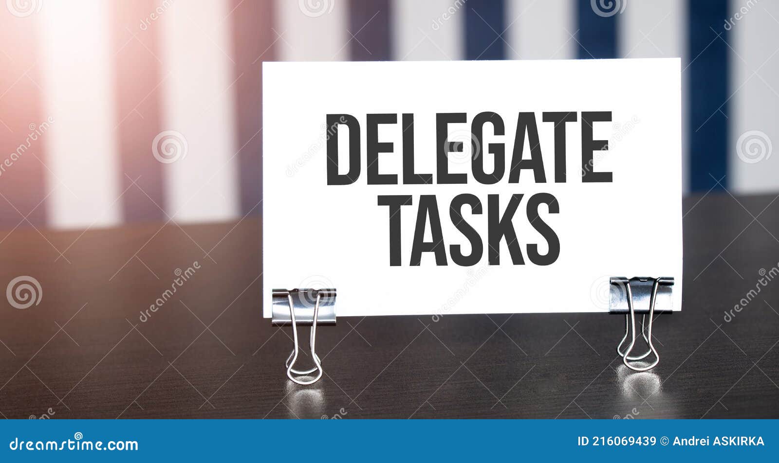 Delegate Tasks Sign on Paper on Dark Desk in Sunlight. Blue and White ...