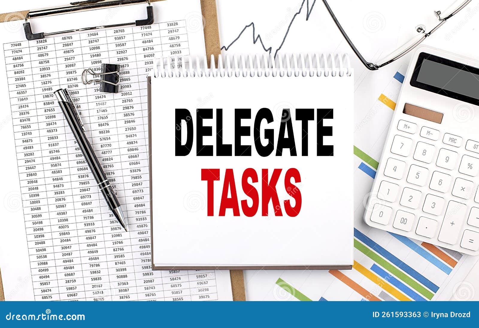 DELEGATE TASKS Text on Notebook with Chart, Calculator and Pen Stock ...
