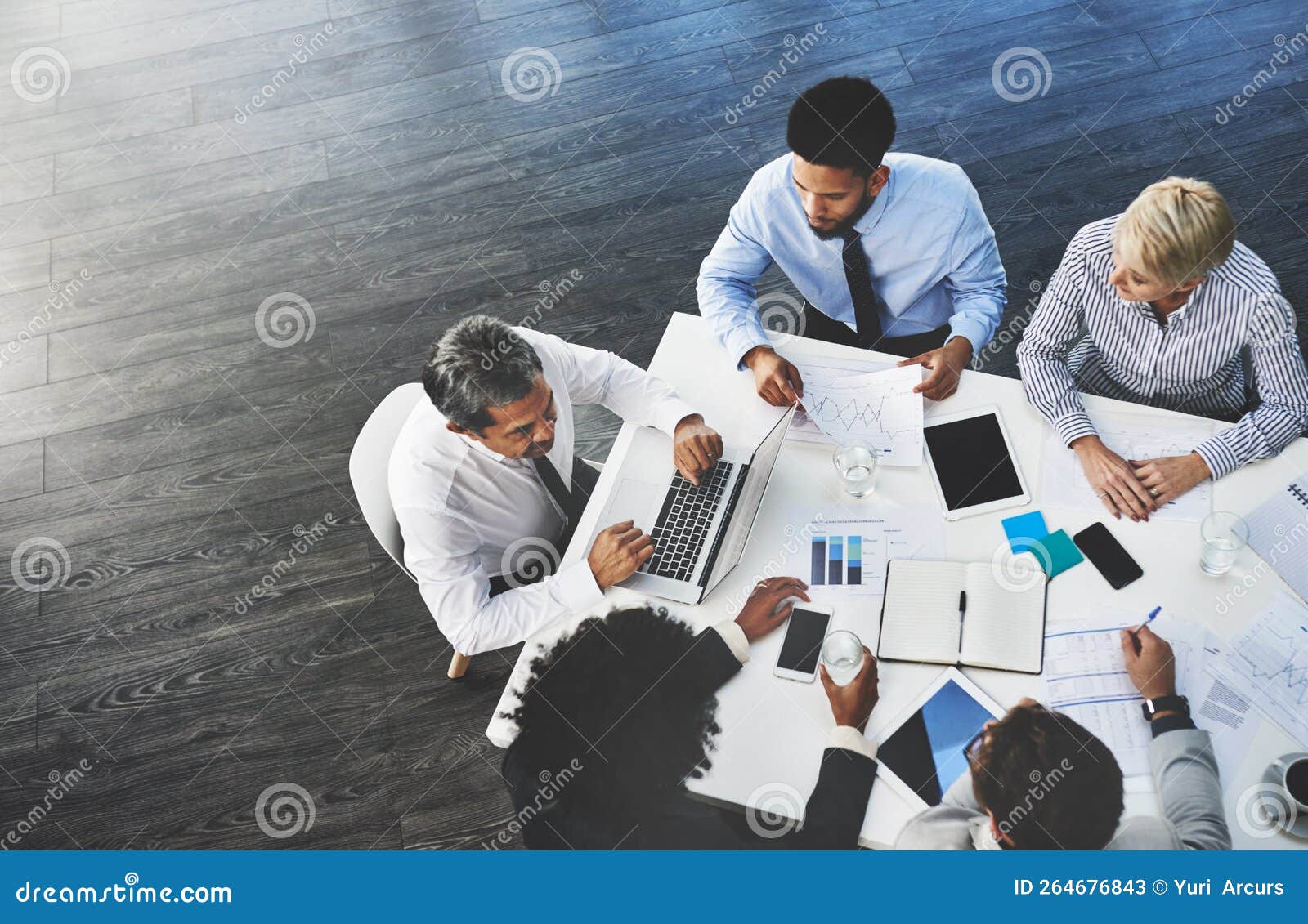 Delegating Tasks Around the Table. a Group of Businesspeople Having a ...