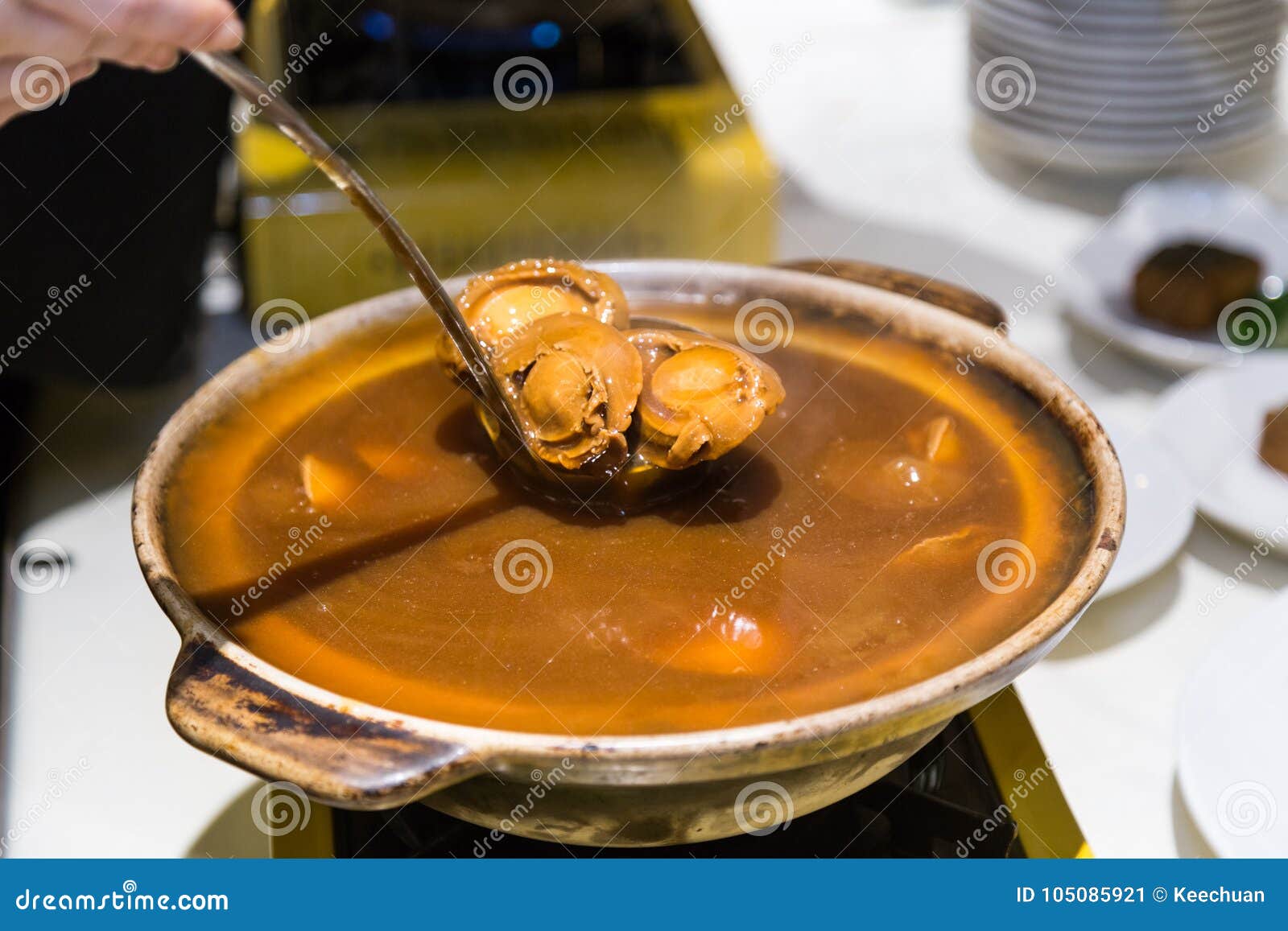 Delicious Braised Abalone Scooped Out from Ceramic Pot for Serving ...