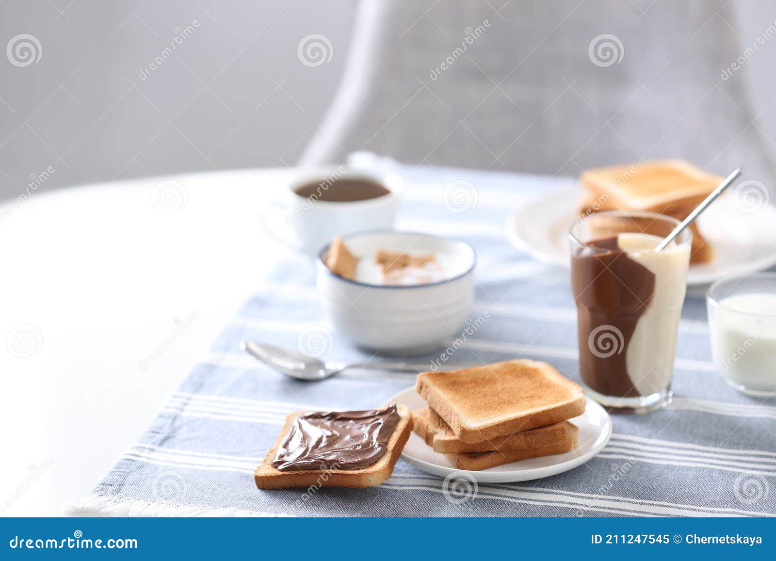 Delicious Breakfast with Toasts and Chocolate Paste on Table Stock ...