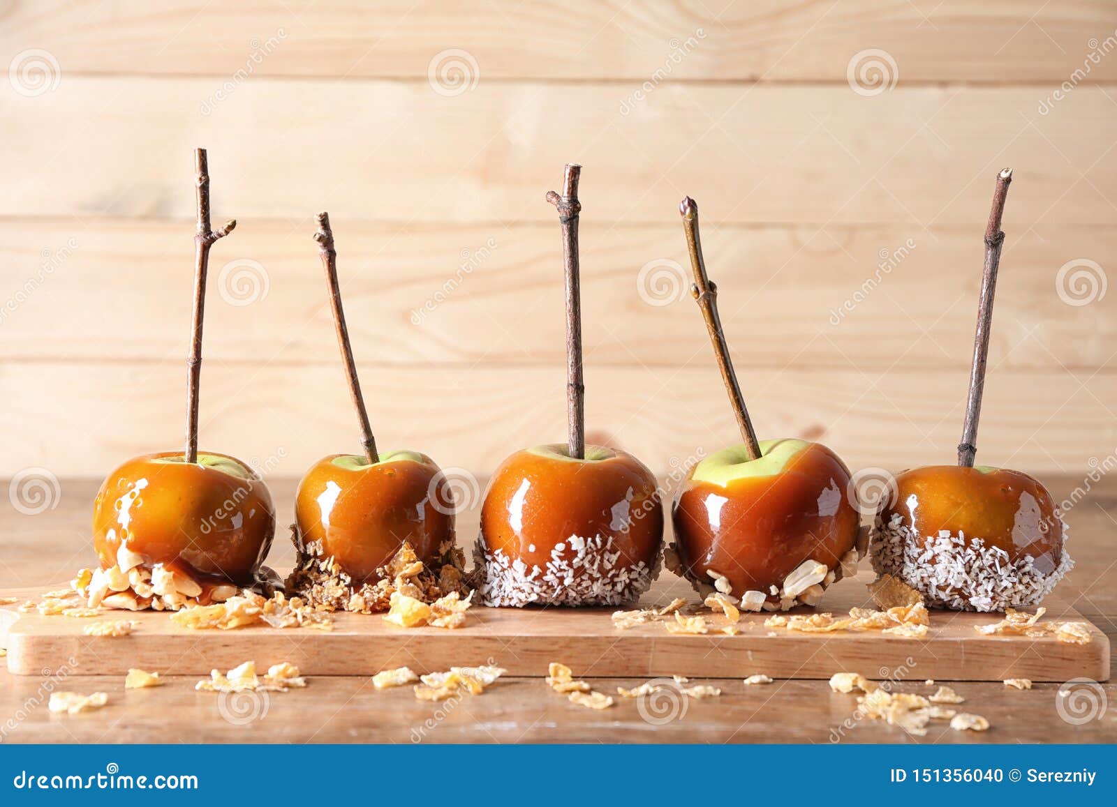 Delicious Caramel Apples with Tree Branches on Wooden Board Stock Photo ...