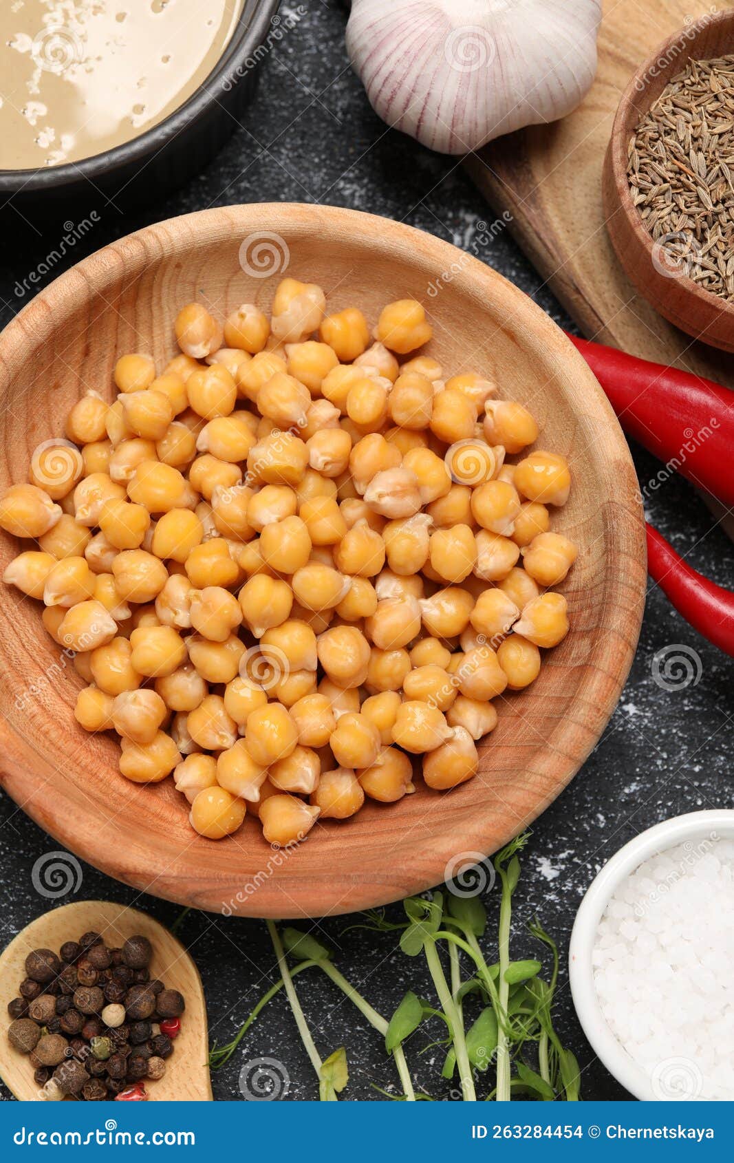 Delicious Chickpeas and Different Products on Black Textured Table ...