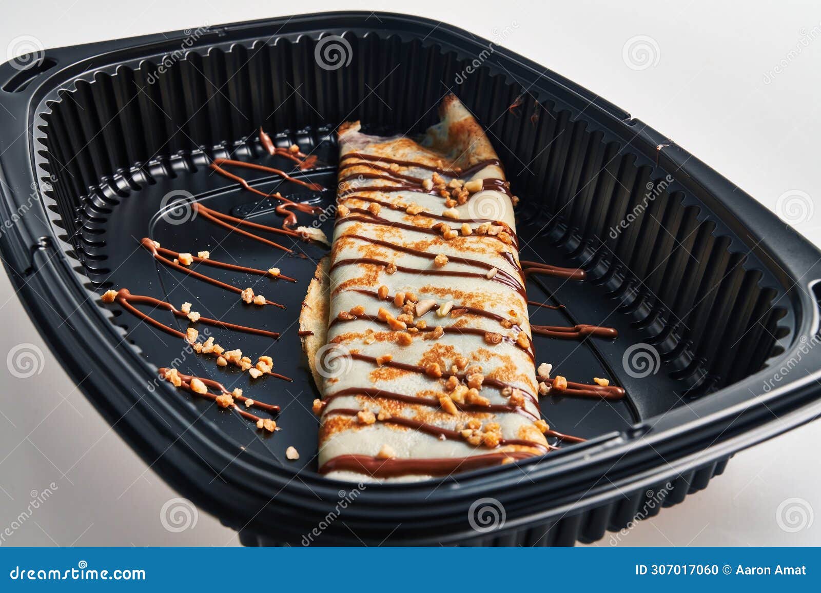 Delicious Crepe Adorned with Chocolate and Caramel Drizzle in a Black ...
