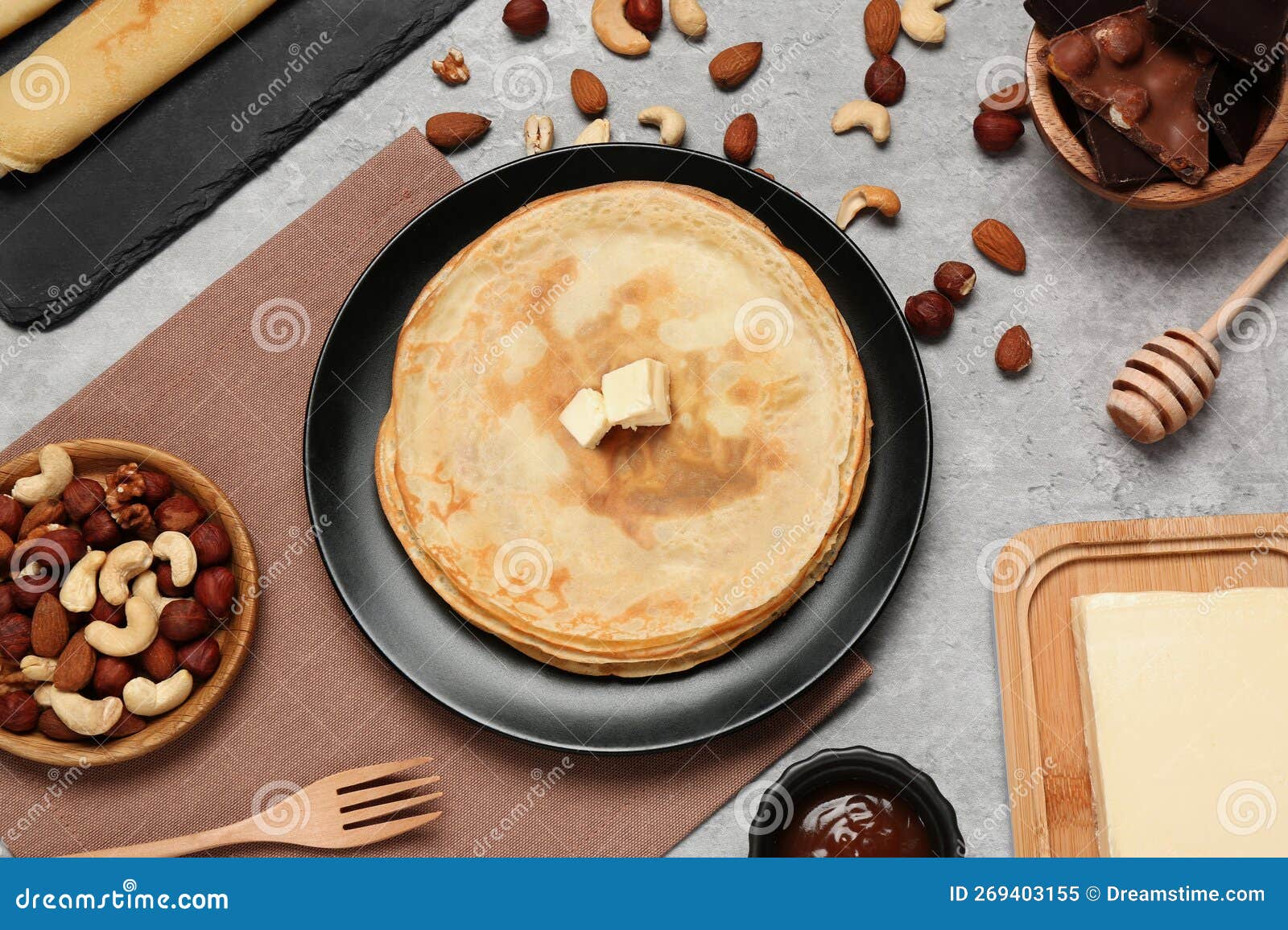 Delicious Crepes with Butter, Chocolate and Nuts on Light Grey Table ...