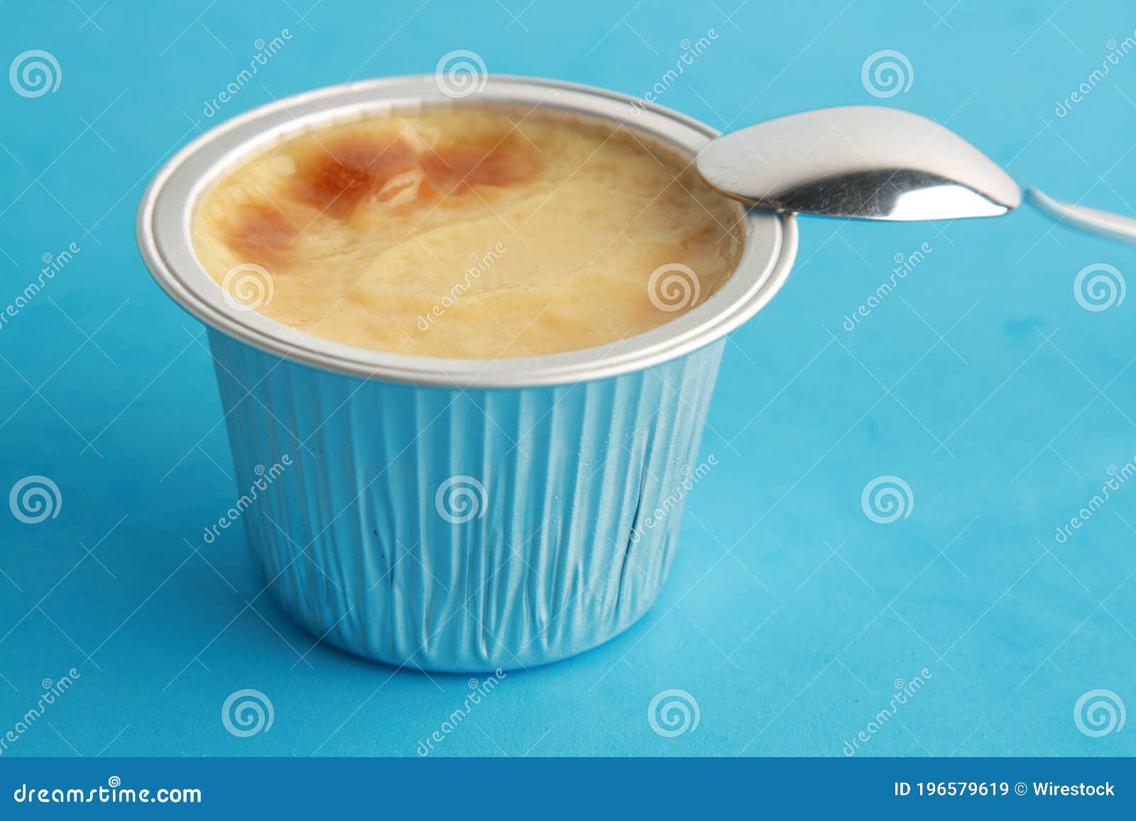 Delicious Egg Flan in an Aluminum Container and a Spoon on a Blue ...