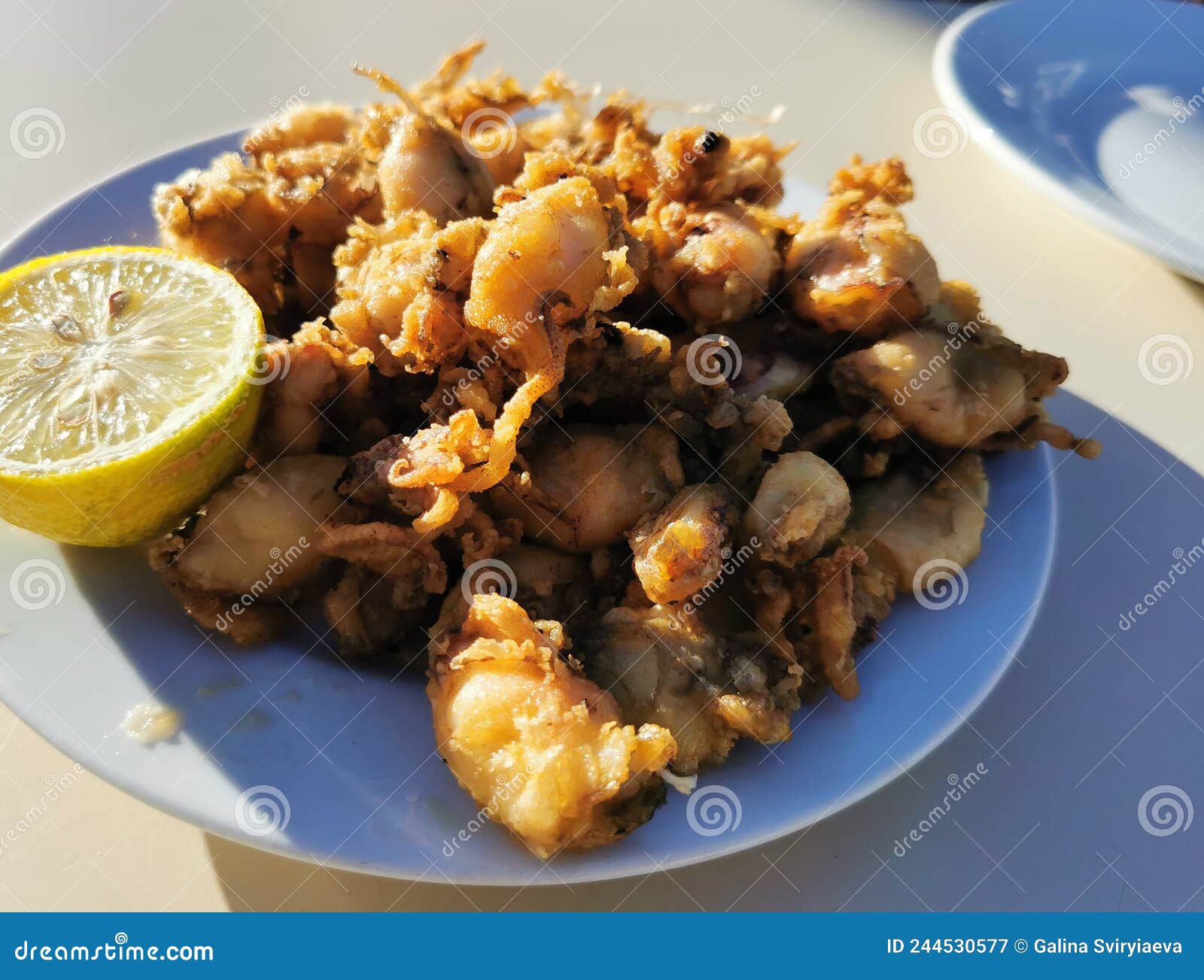Delicious Fried Baby Octopus with Lemon Stock Image - Image of dinner ...