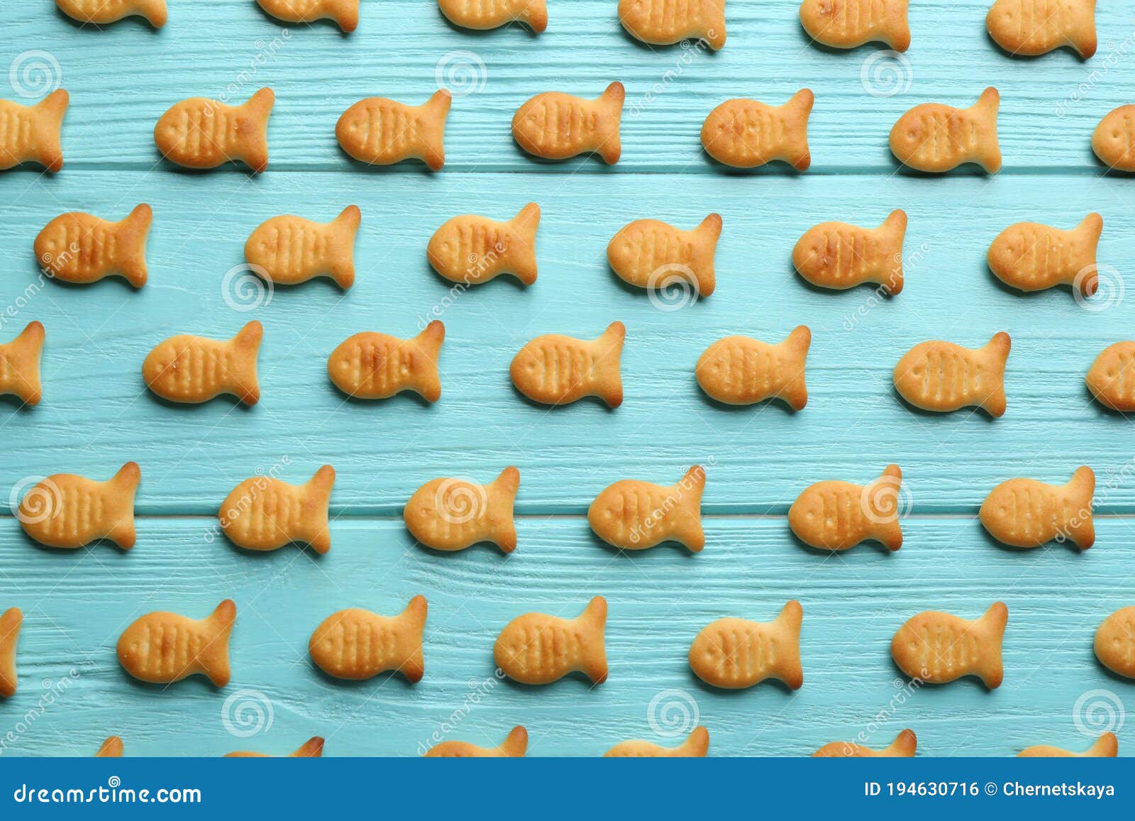 Delicious Goldfish Crackers on Blue Wooden Table, Flat Lay Stock Photo ...