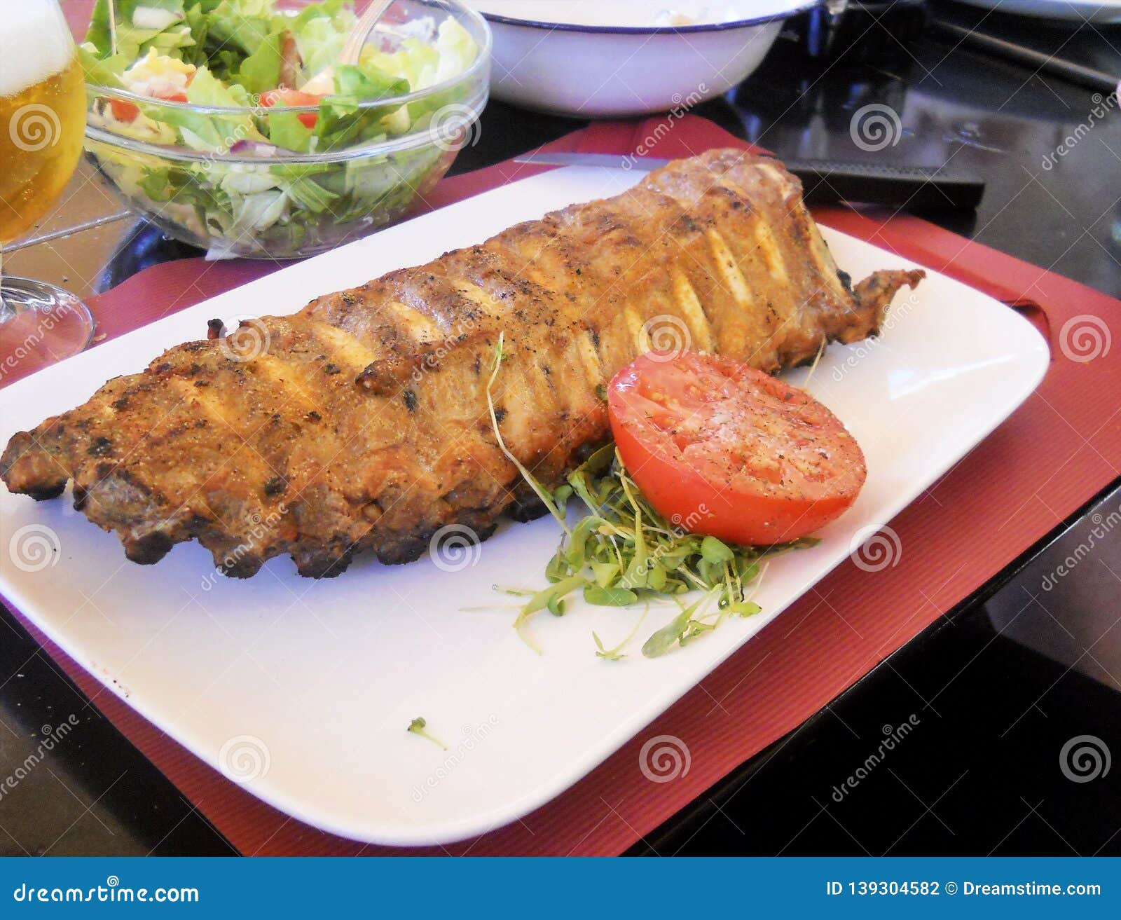 Delicious Grilled Ribs with Tomato and Lettuce on White Plate Stock ...
