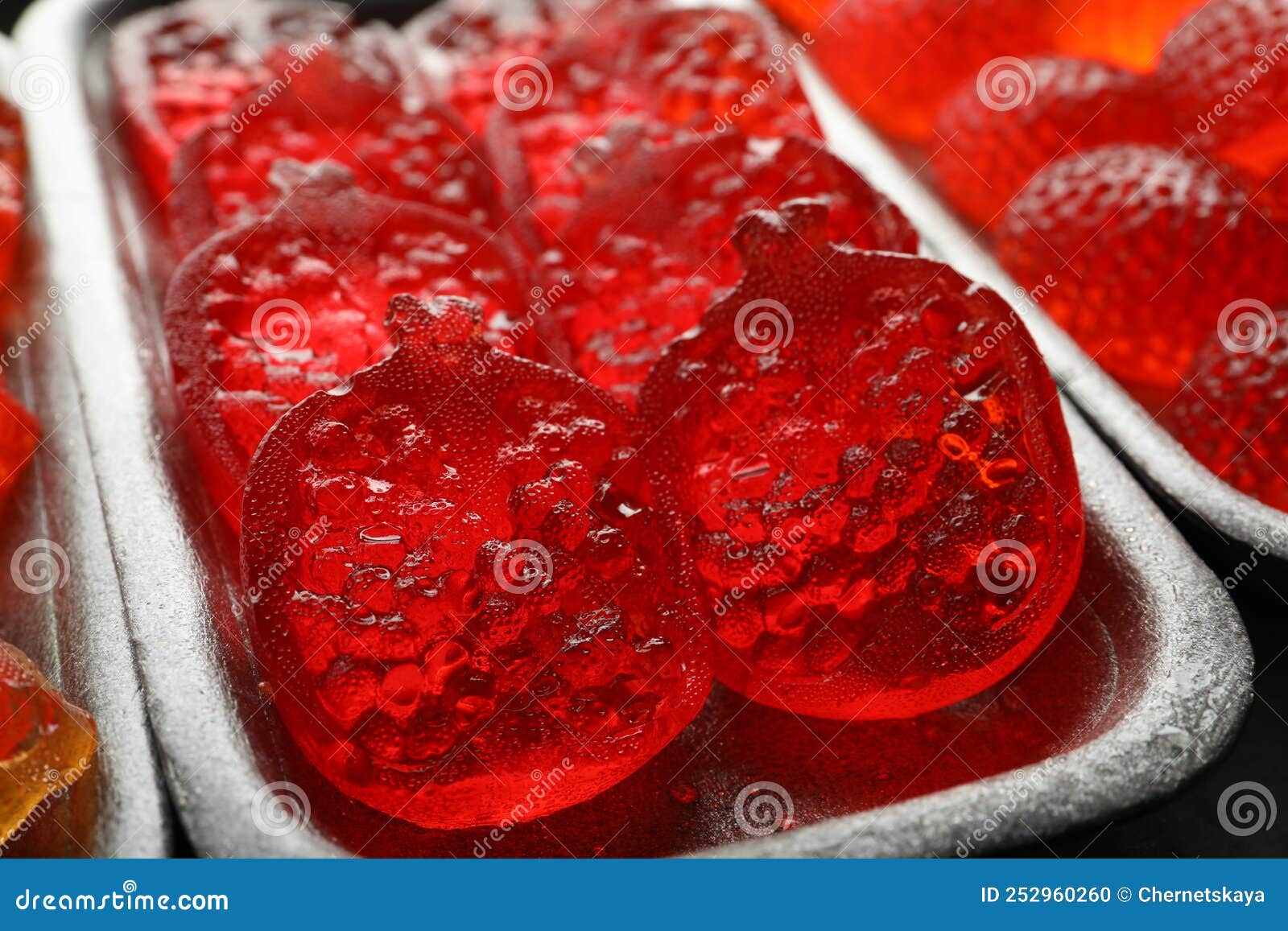 Delicious Gummy Pomegranate Candies in Container, Closeup Stock Photo ...