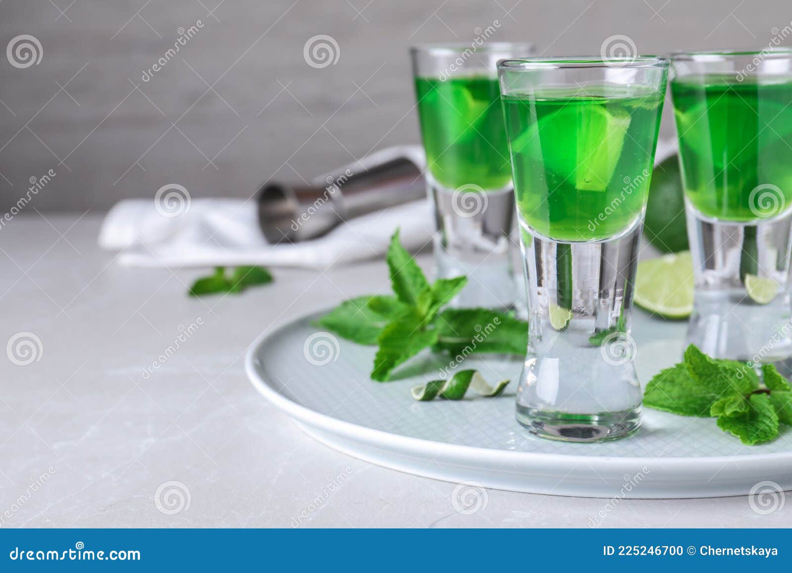 Delicious Mint Liqueur with Lime and Green Leaves on White Table. Space ...