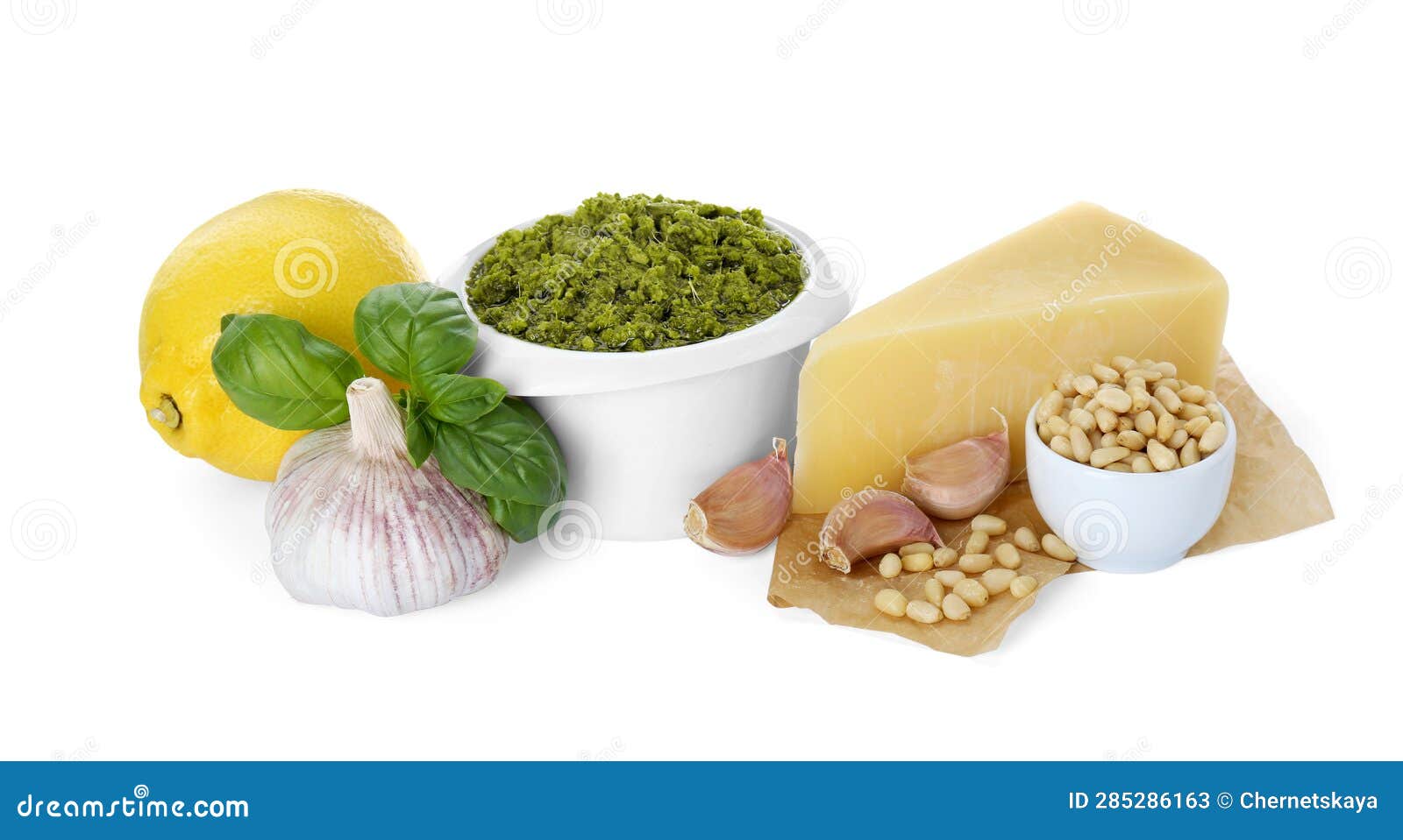 Delicious Pesto Sauce In Bowl And Ingredients Isolated On White Stock