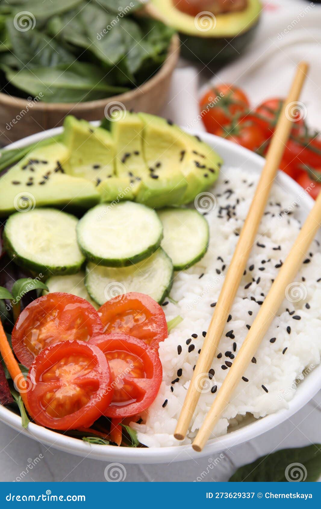 Delicious Poke Bowl with Vegetables, Avocado and Mesclun on White Table ...