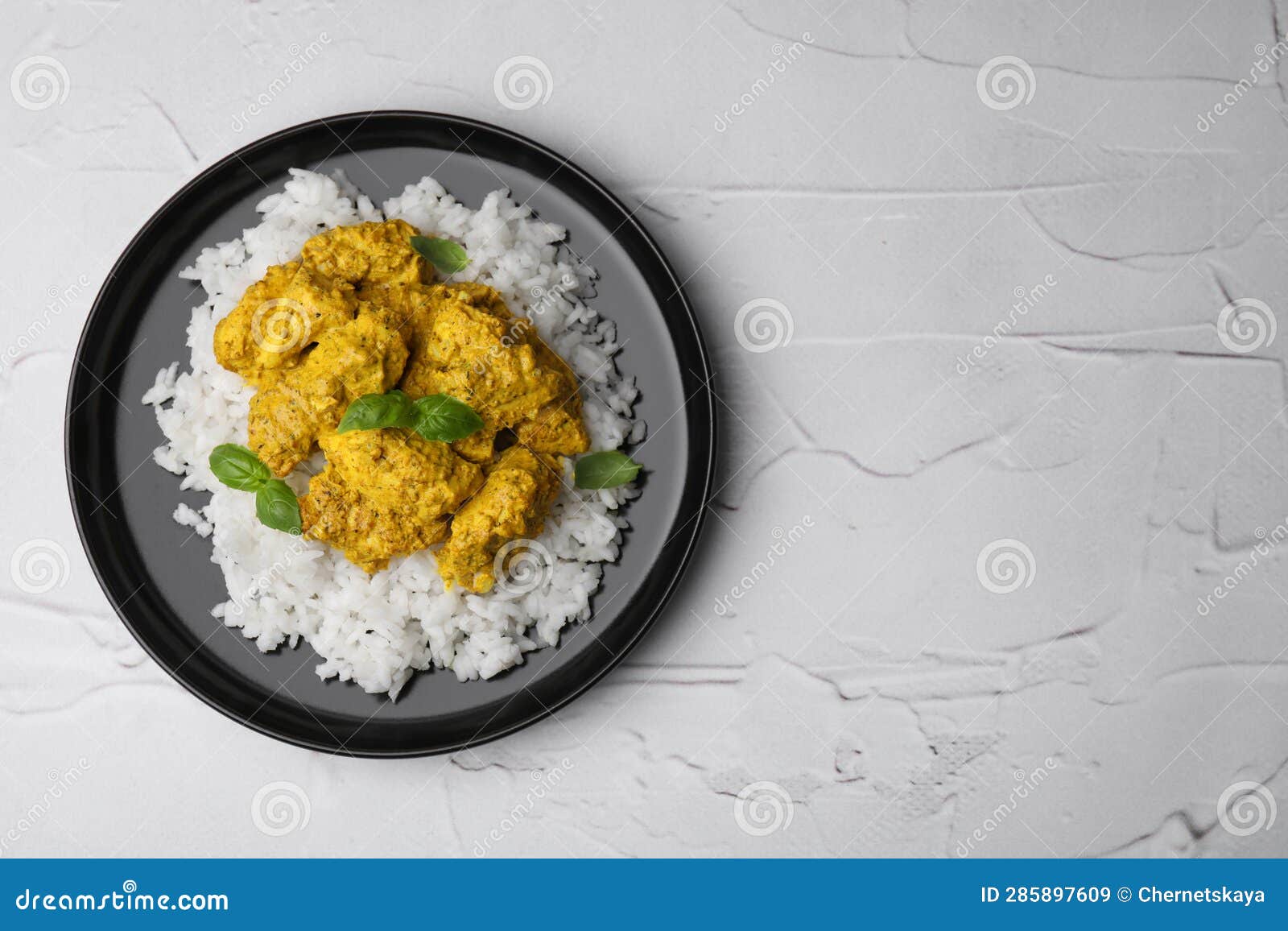 Delicious Rice and Chicken with Curry Sauce on White Textured Table ...