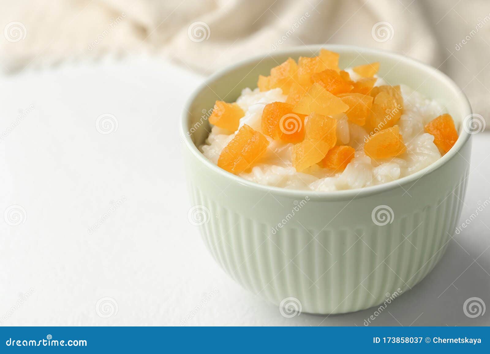 Delicious Rice Pudding with Dried Apricots on Table, Closeup. Space for ...