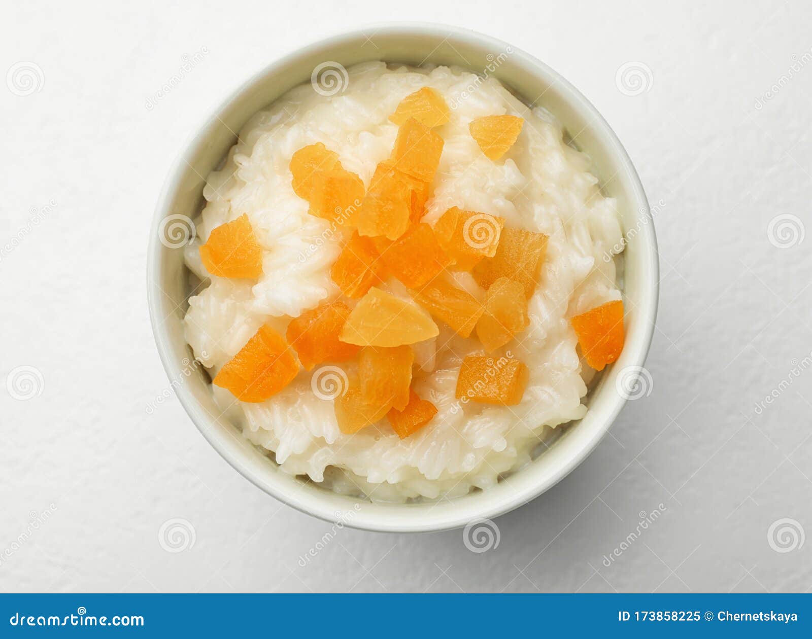 Delicious Rice Pudding with Dried Apricots on White Table, Top View ...