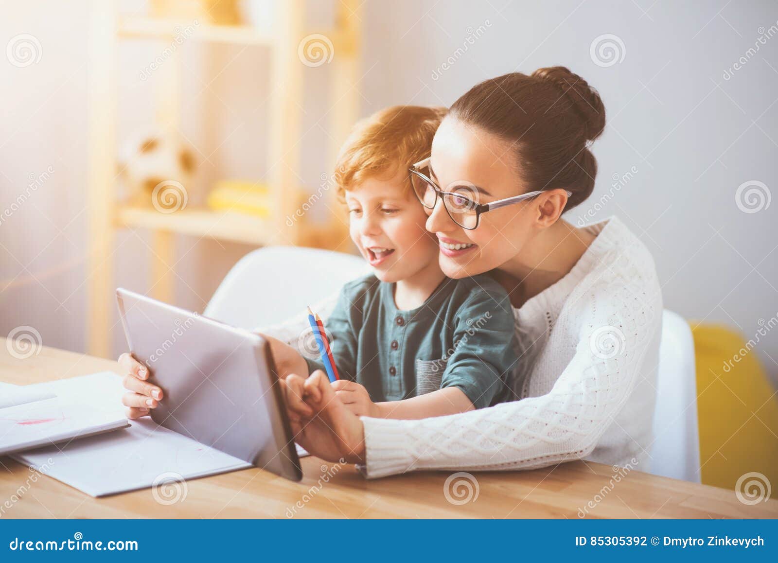 Delighted Mother Teaching Her Son Using a Tablet Stock Photo - Image of ...
