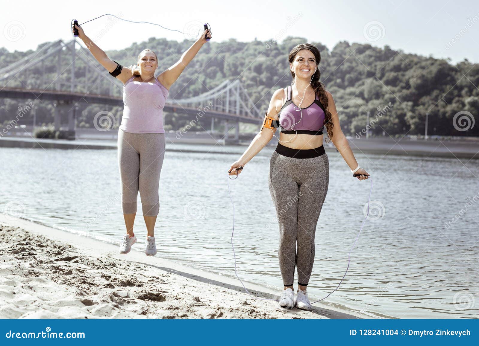 Delighted Positive Women Jumping on the Beach Stock Photo - Image of ...