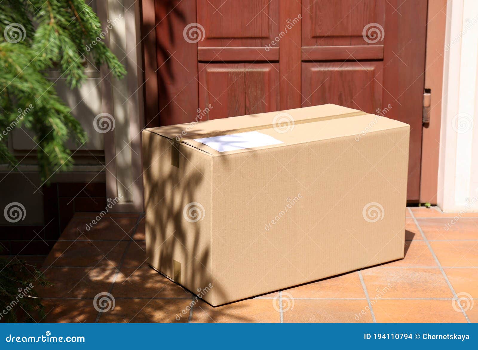 Delivered Parcel on Porch Near Door Stock Photo - Image of entryway ...