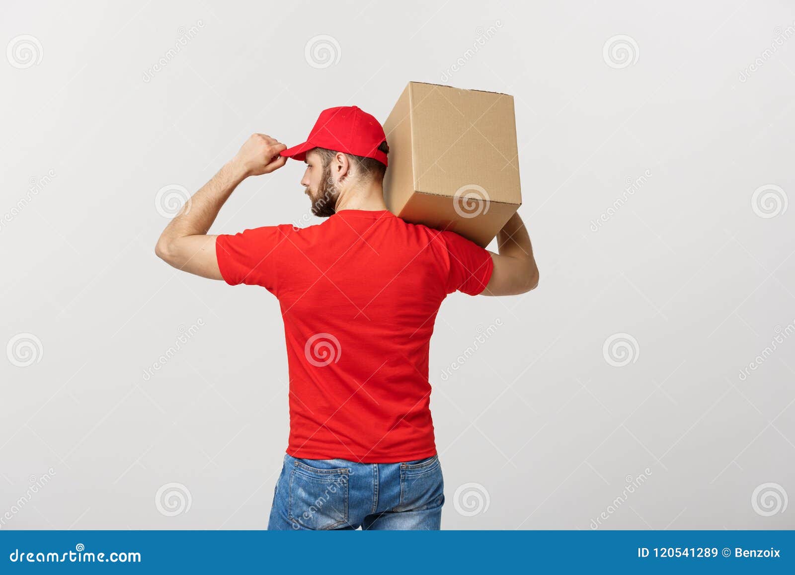 Delivery Concept - Back View of Handsome Caucasian Delivery Man with ...