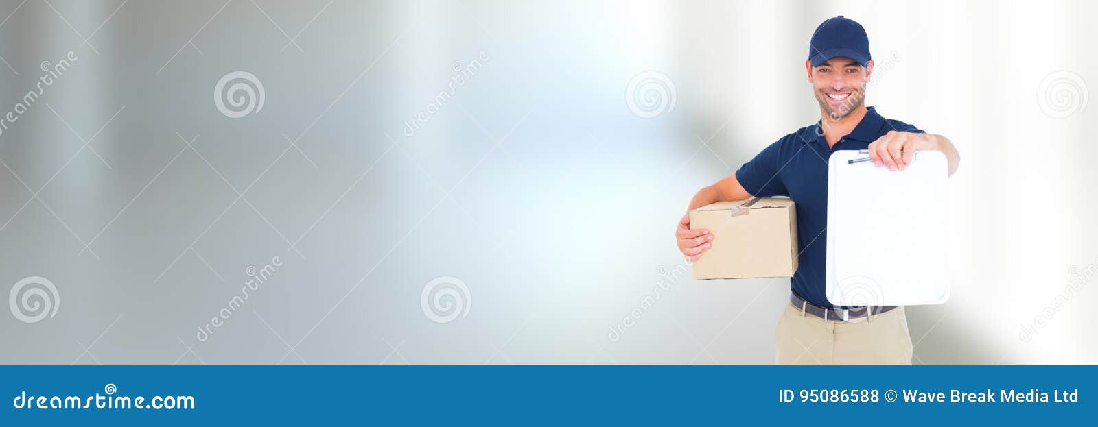 Delivery Courier Holding Parcel and Form in Front of Blurred Background ...