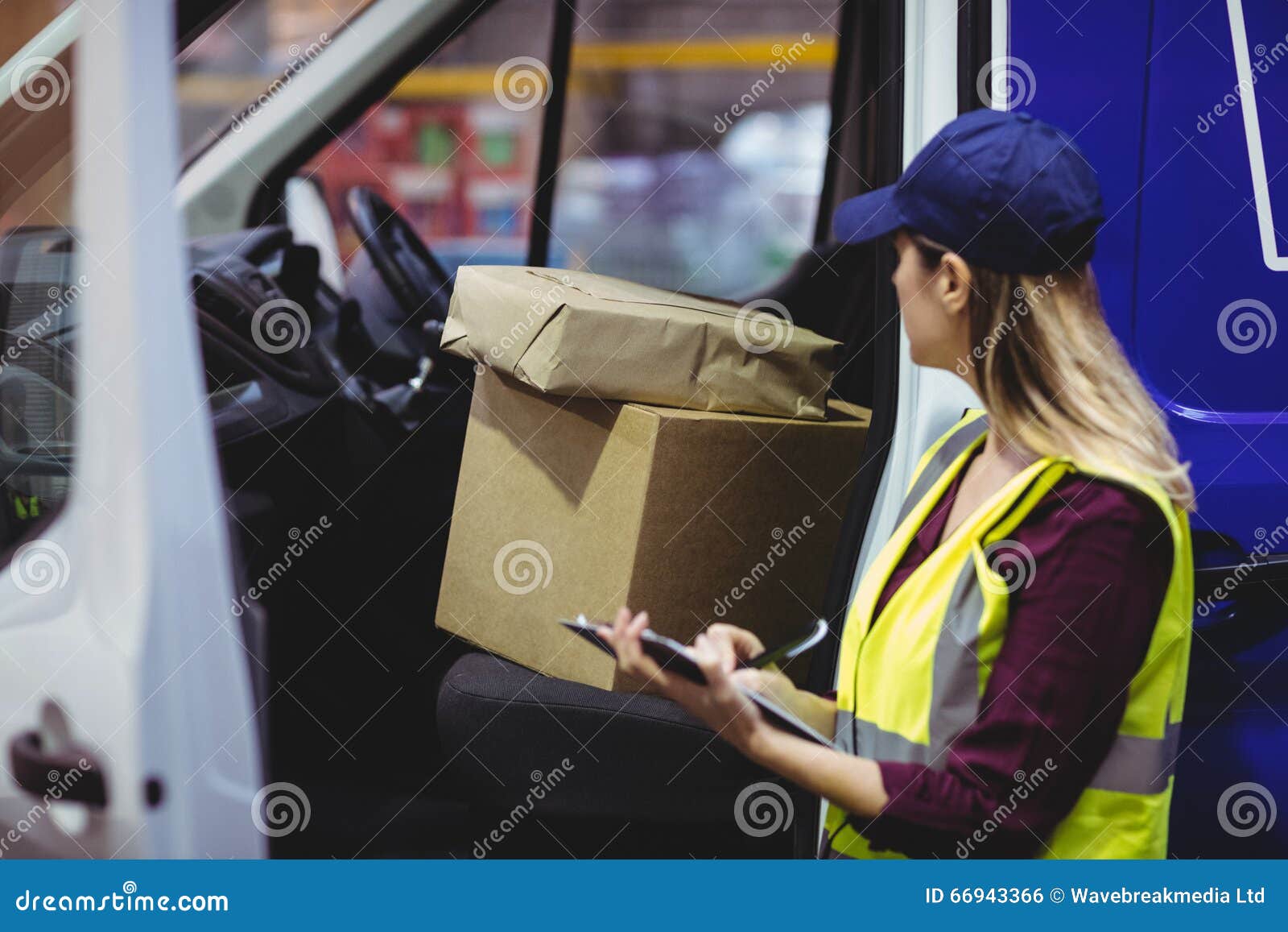 Delivery Driver Checking His List on Clipboard Stock Photo - Image of ...