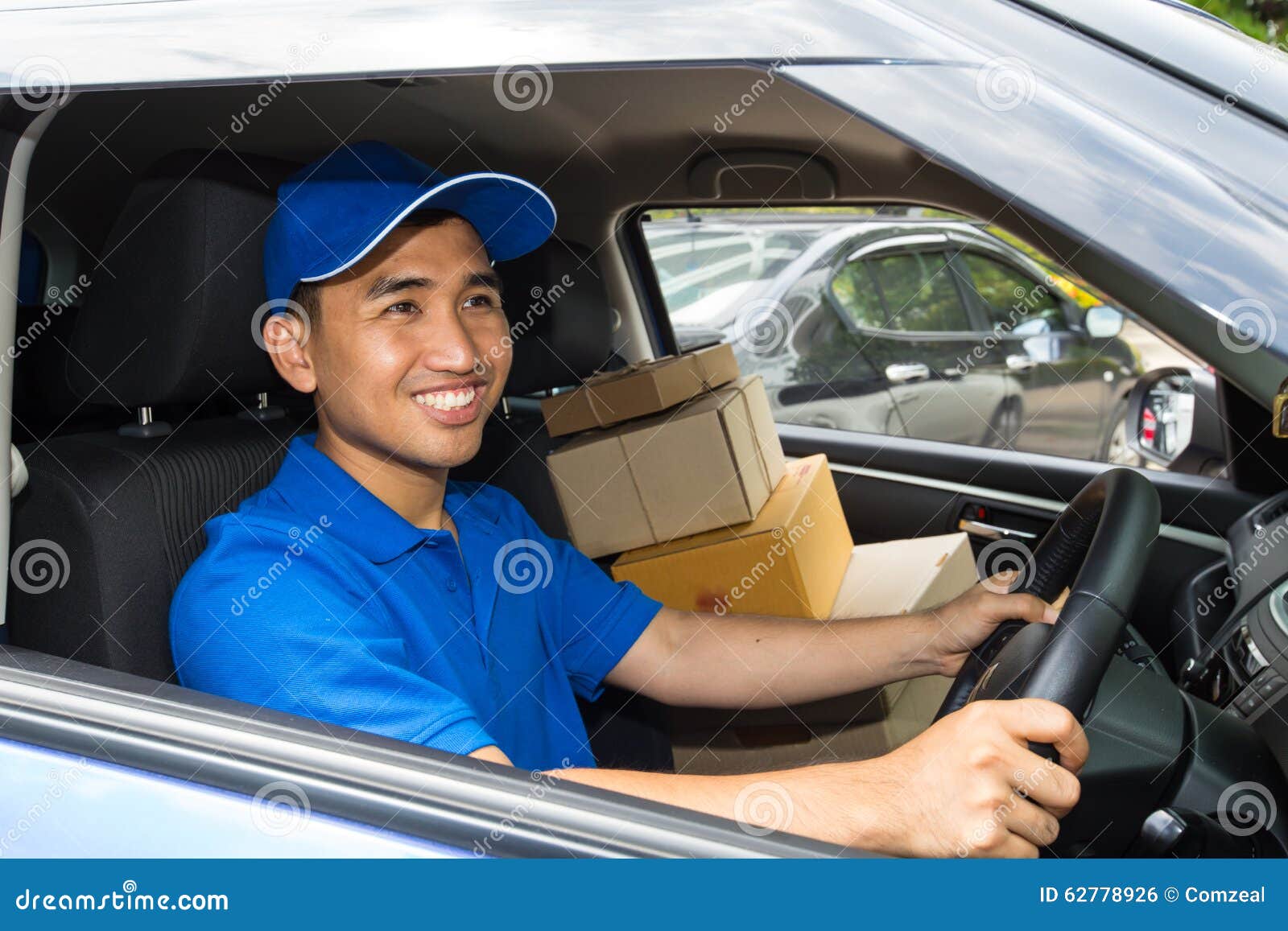 Delivery Driver Driving with Parcels on Seat Stock Photo - Image of ...