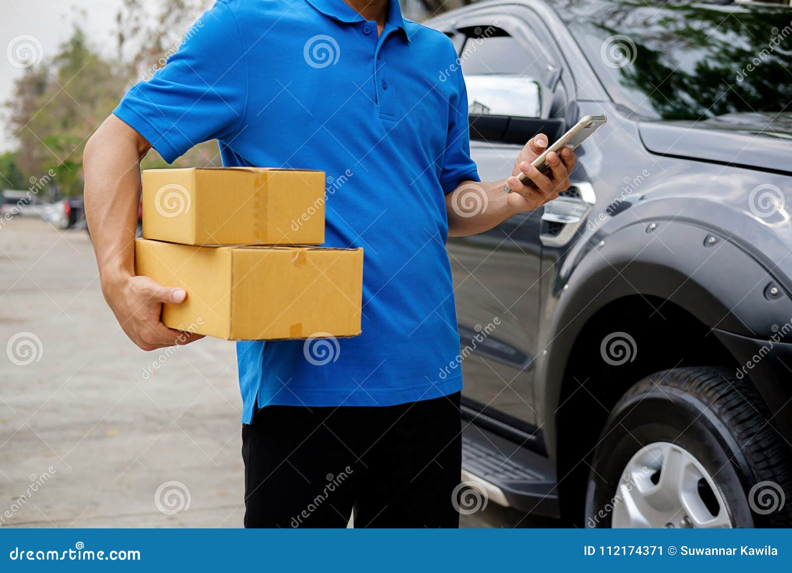 Delivery Driver Driving Van with Parcels on Seat Outside Warehouse ...