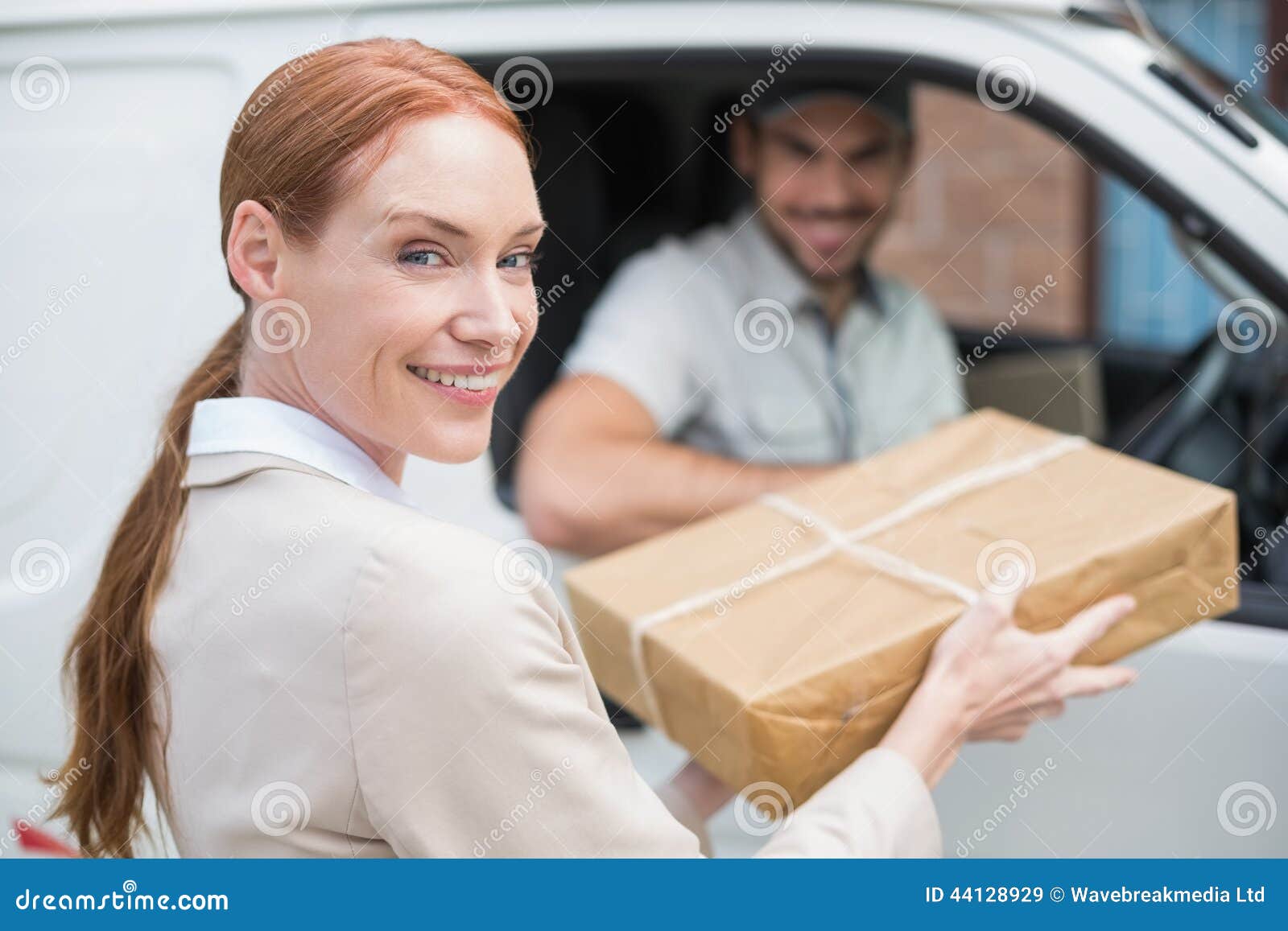 Delivery Driver Handing Parcel To Customer in His Van Stock Image ...