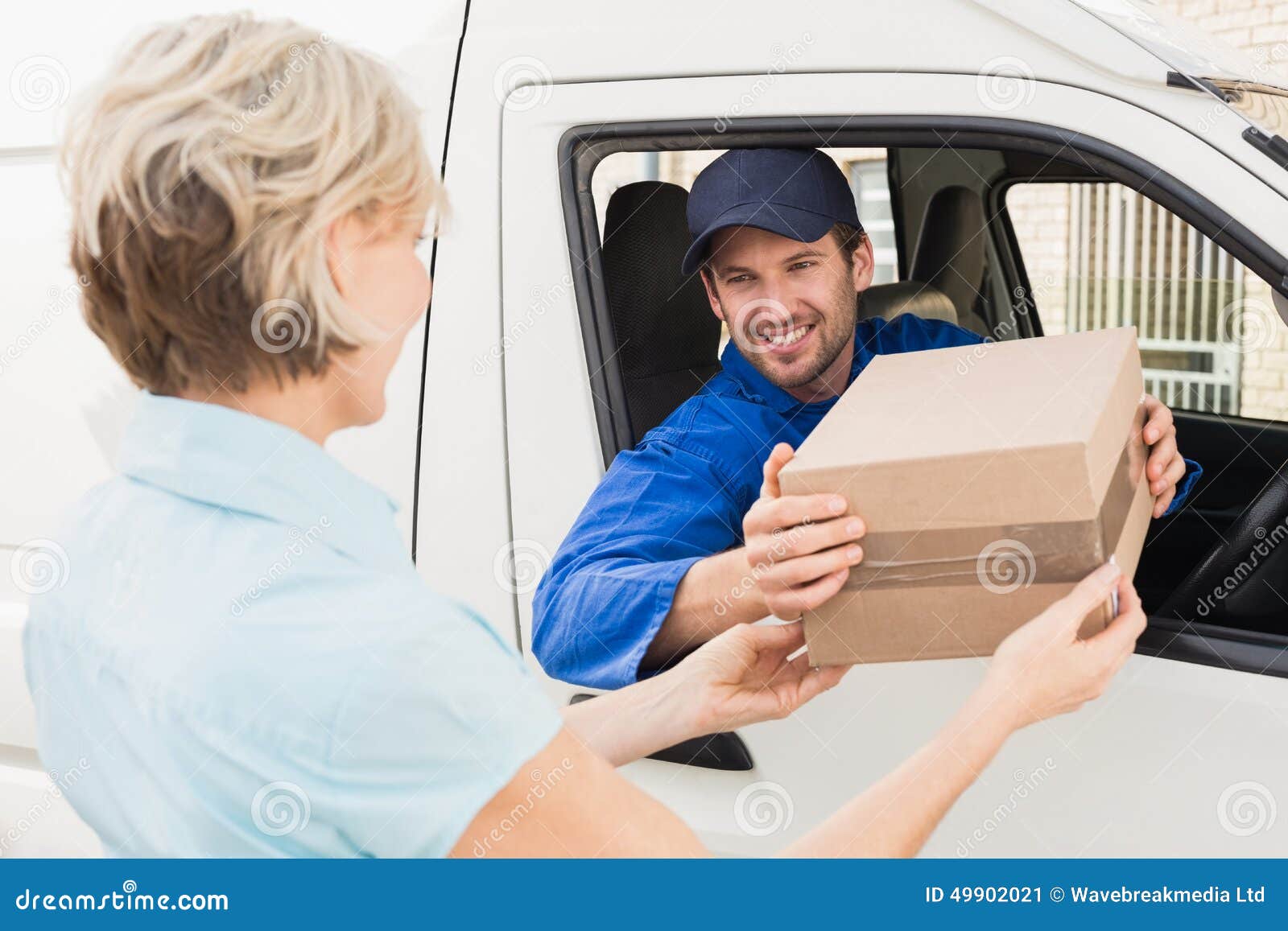 Delivery Driver Handing Parcel To Customer in His Van Stock Image ...
