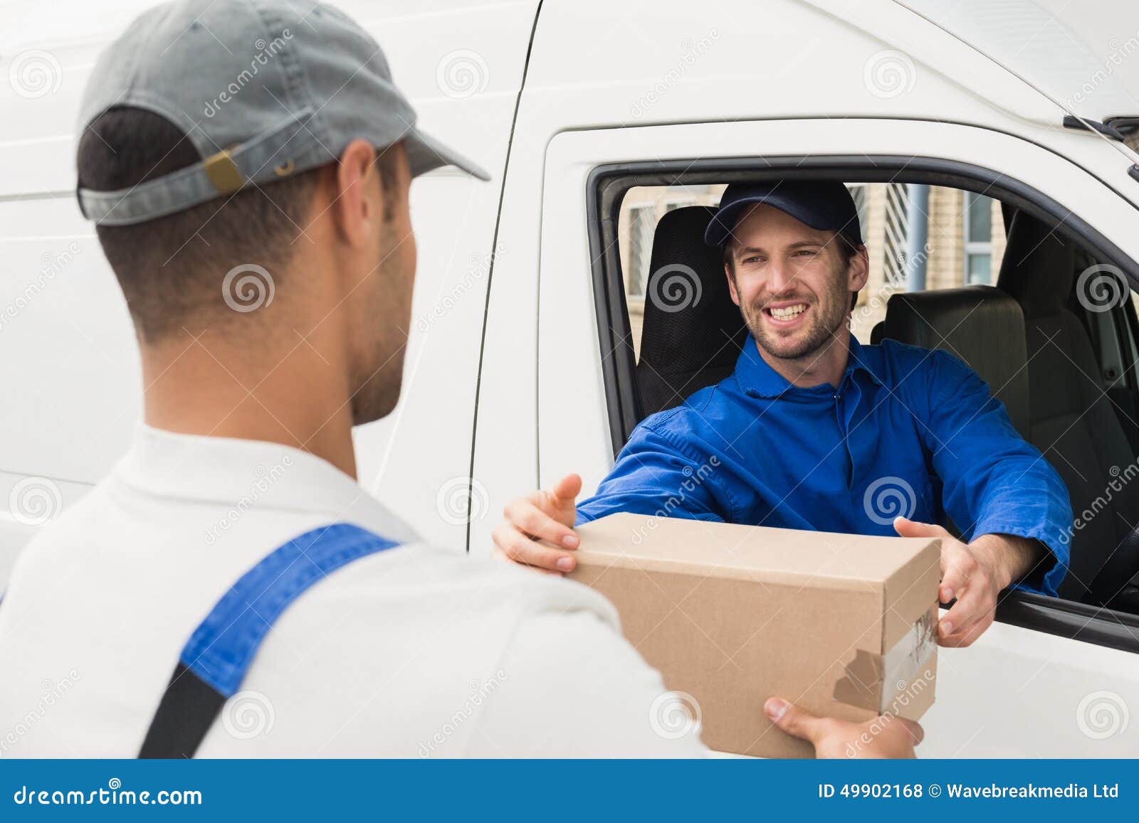 Delivery Driver Handing Parcel To Customer in His Van Stock Photo ...