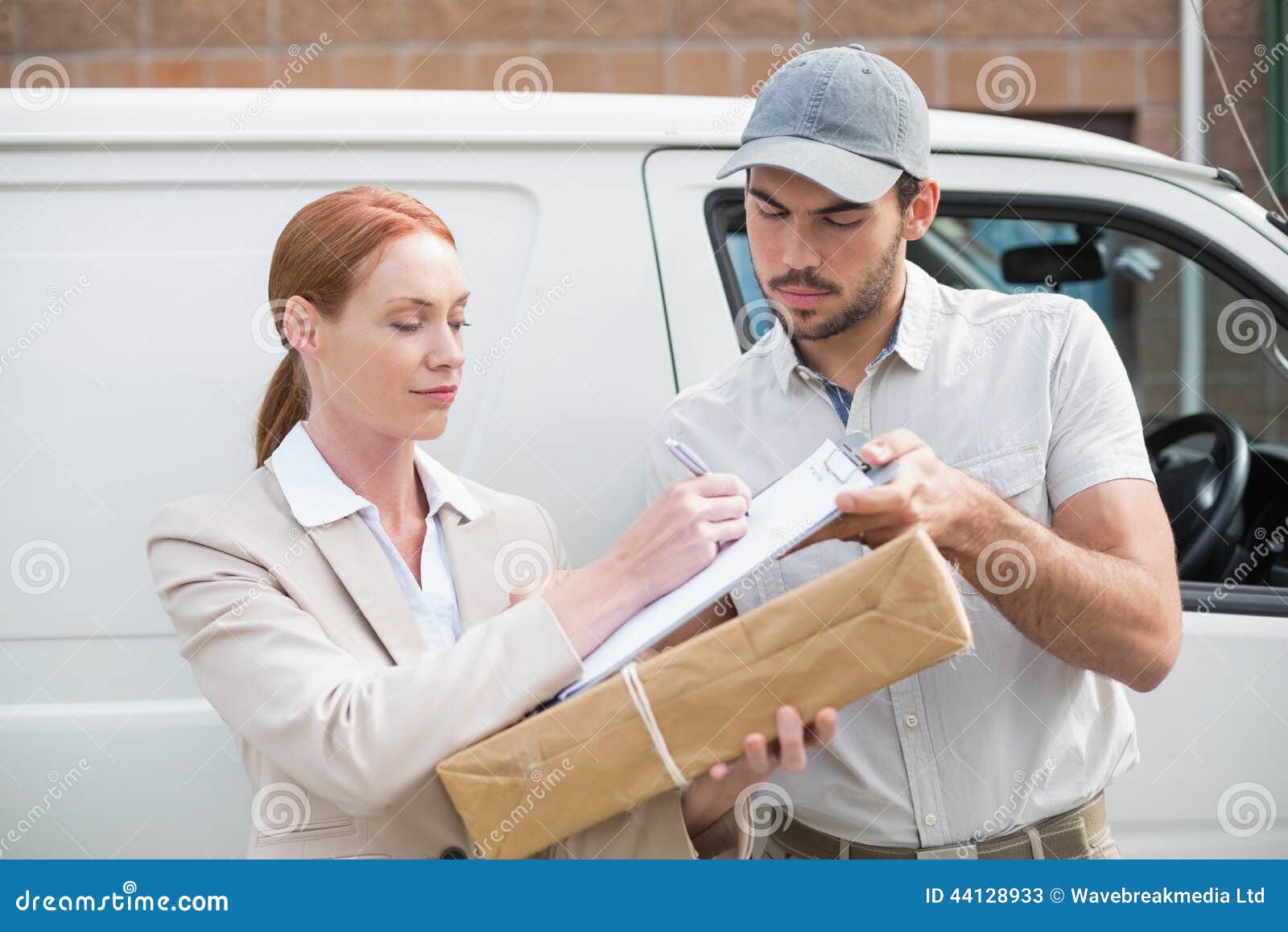 Delivery Driver Handing Parcel To Customer Outside Van Stock Image ...