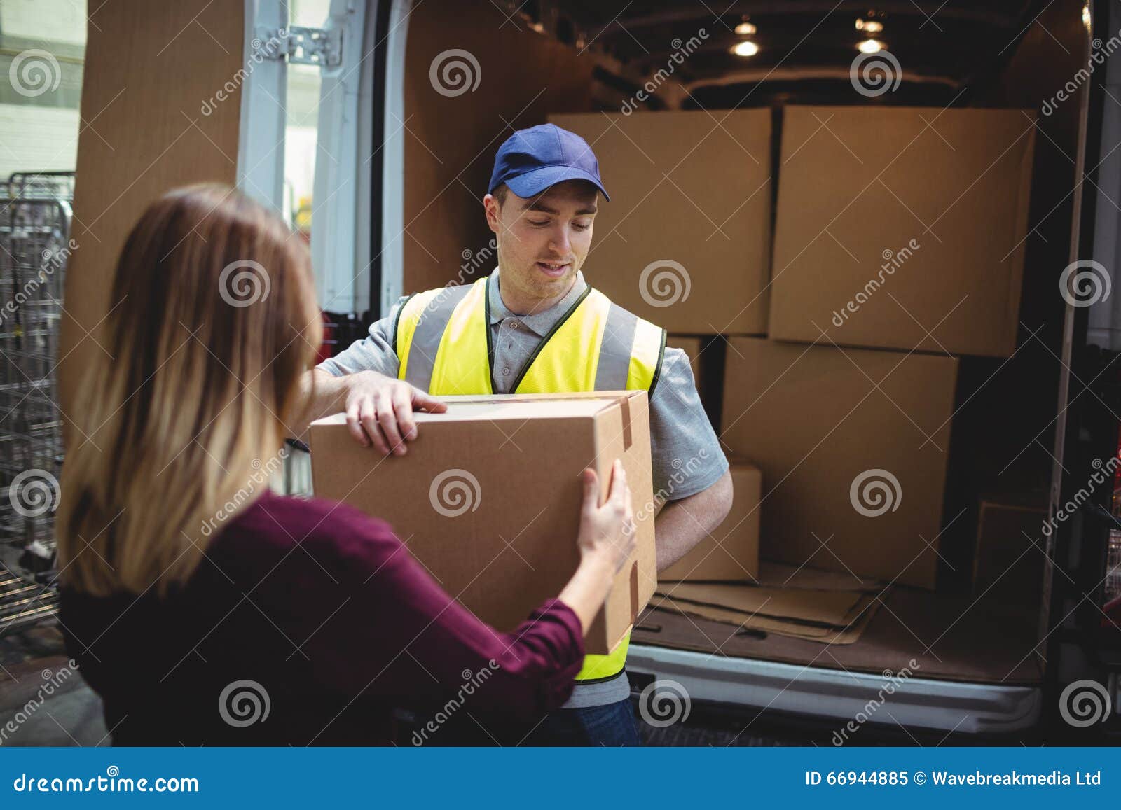 Delivery Driver Handing Parcel To Customer Outside Van Stock Image ...