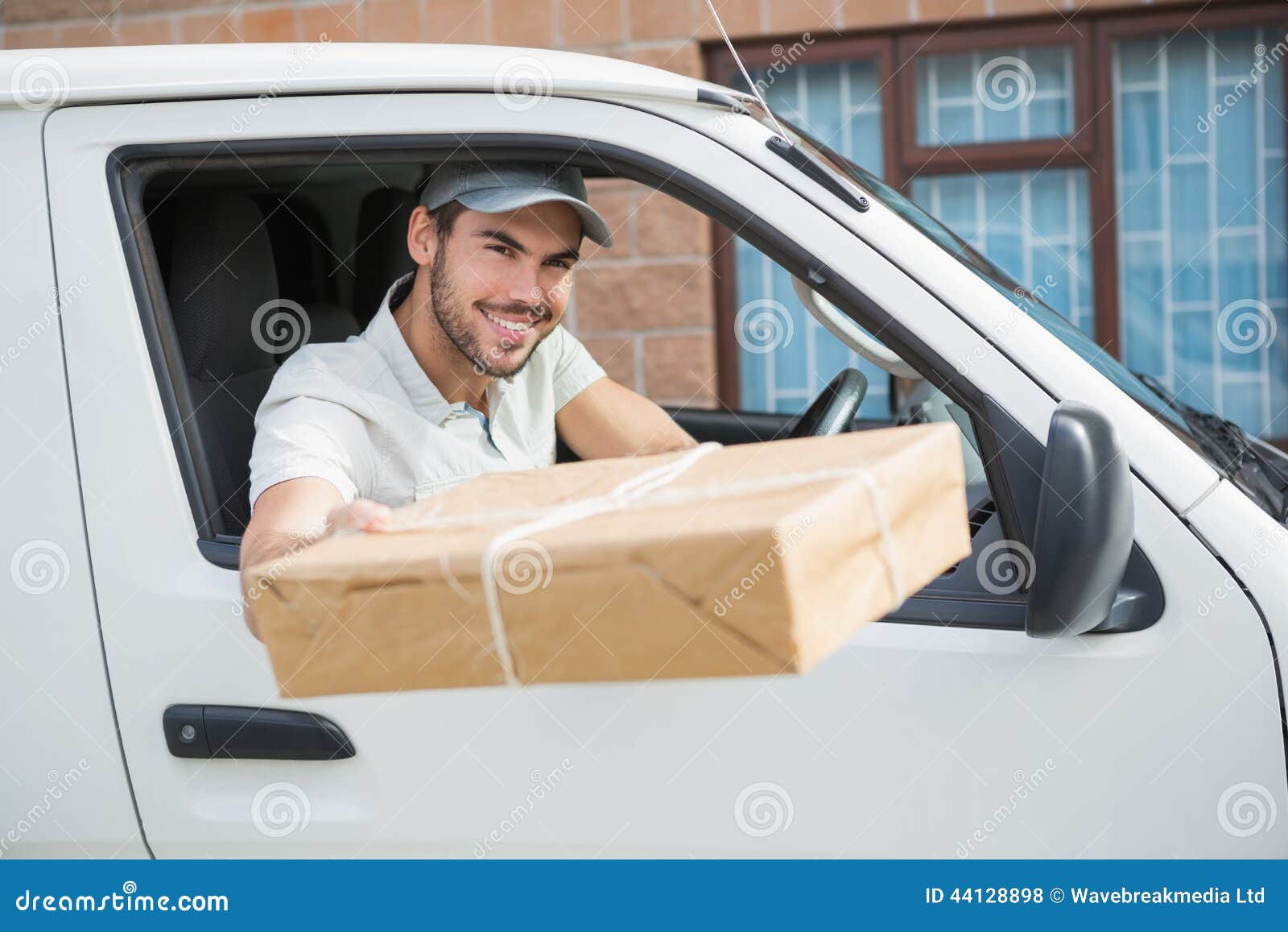 Delivery Driver Offering Parcel from His Van Stock Photo - Image of ...