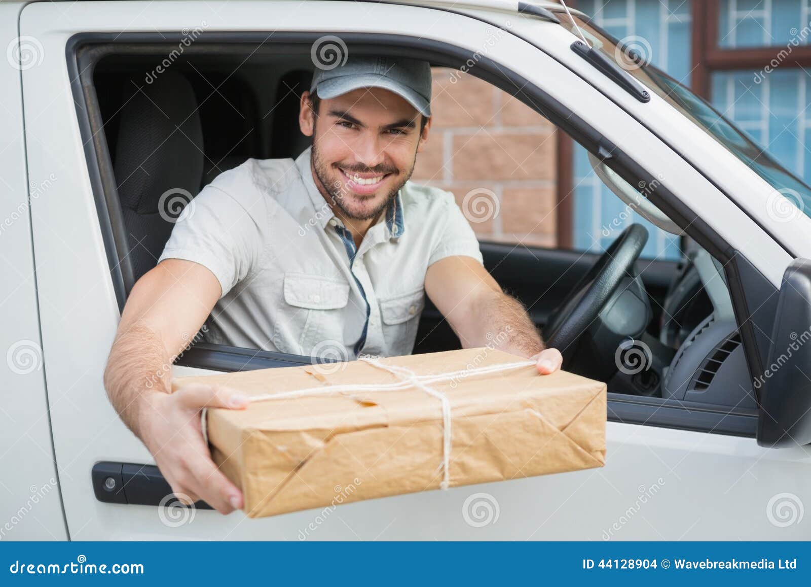 Delivery Driver Offering Parcel from His Van Stock Photo - Image of ...