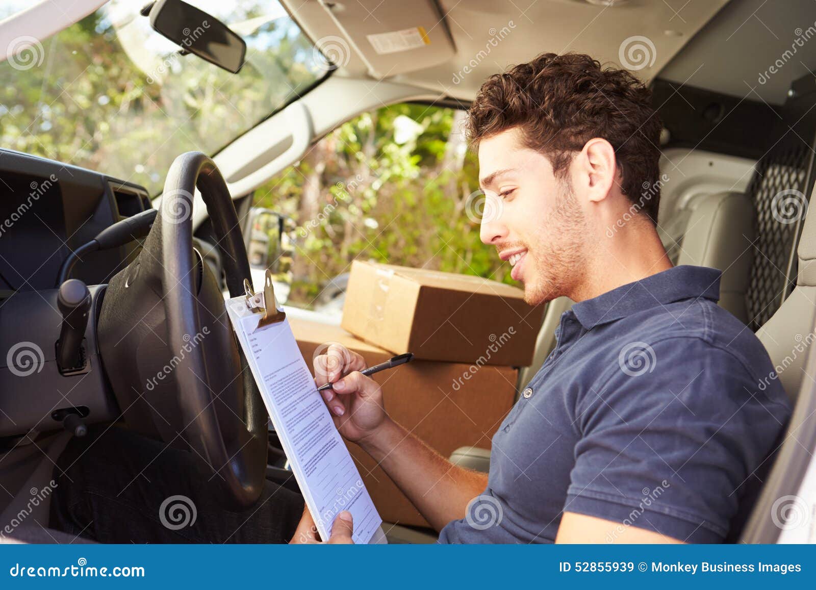 Delivery Driver Sitting in Van Filling Out Paperwork Stock Image ...