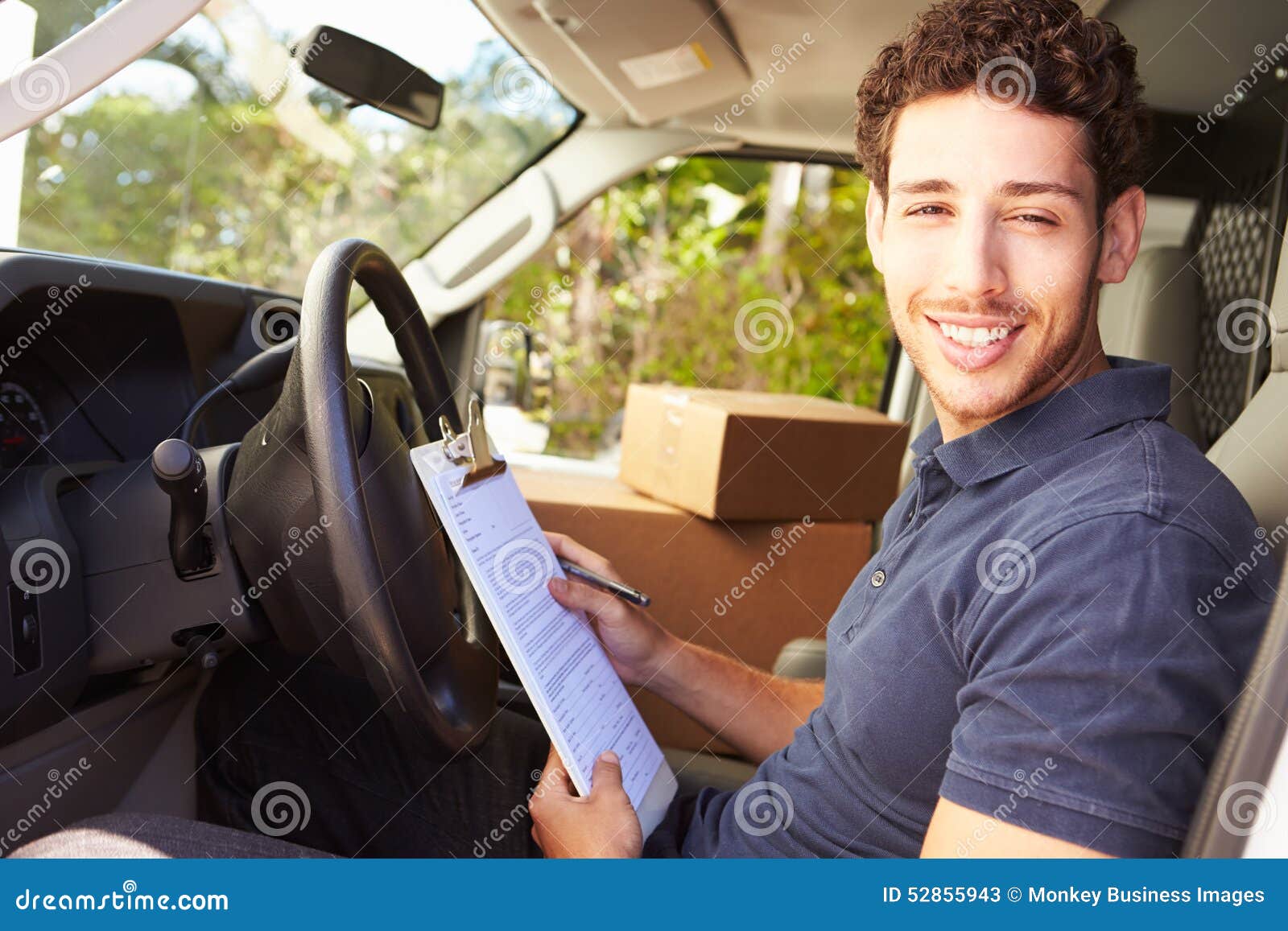 Delivery Driver Sitting in Van Filling Out Paperwork Stock Image ...