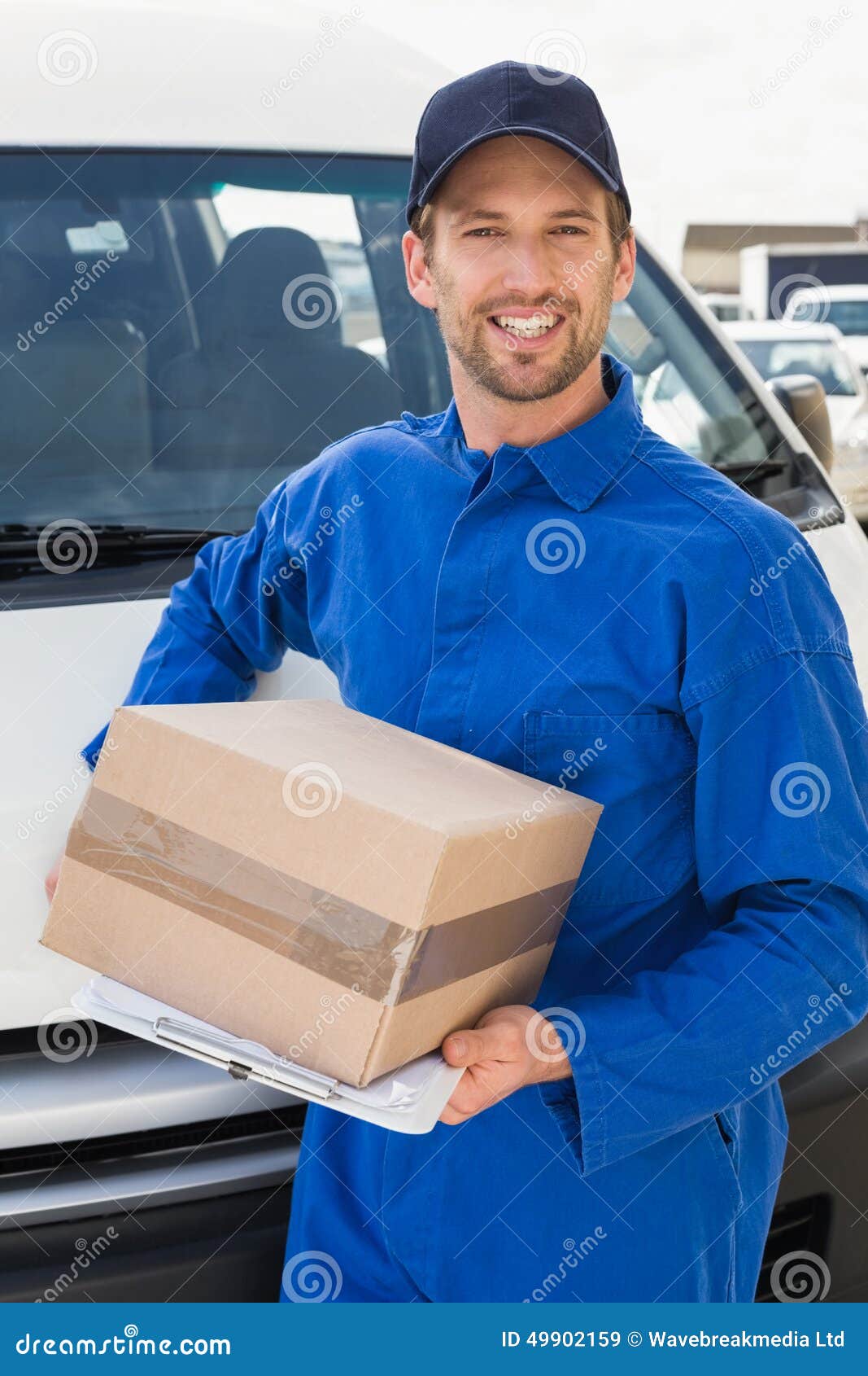 Delivery Driver Smiling at Camera by His Van Holding Parcel Stock Image ...