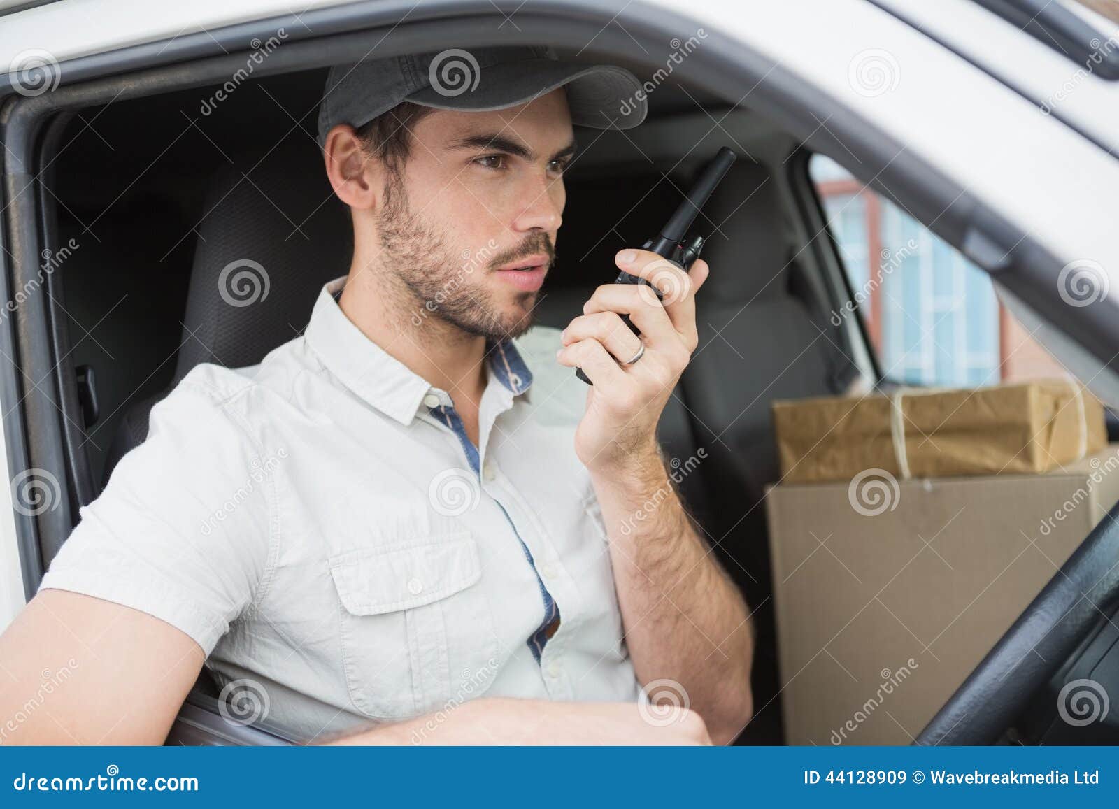 Delivery Driver Talking on Walkie Talkie in His Van Stock Image - Image ...