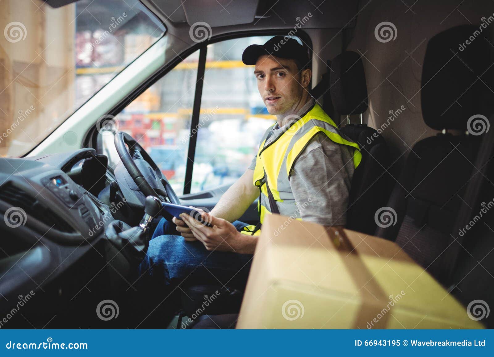 Delivery Driver Using Tablet in Van with Parcels on Seat Stock Image ...